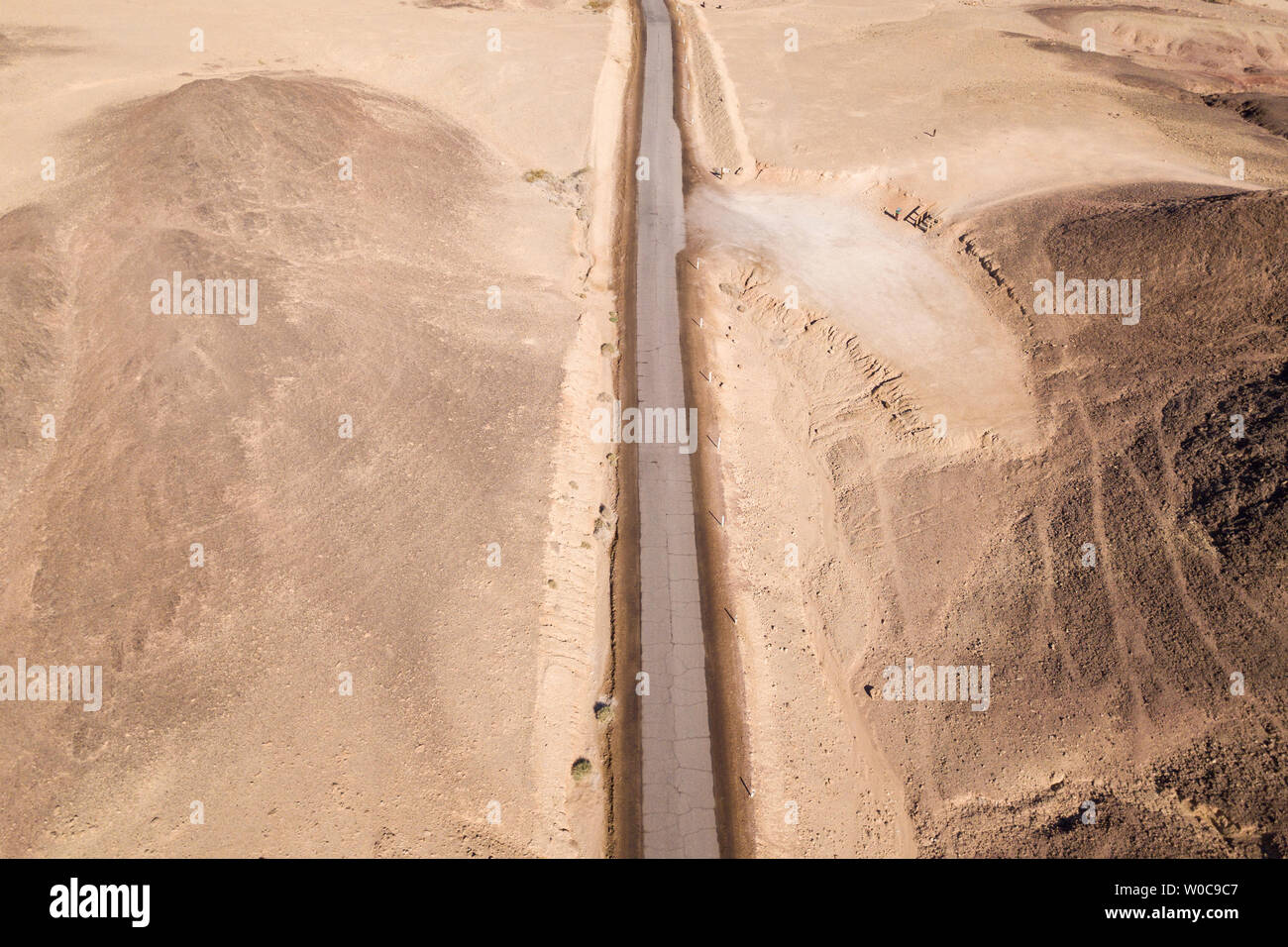 Old Desert road with cracked asphalt, Top down aerial image Stock Photo ...