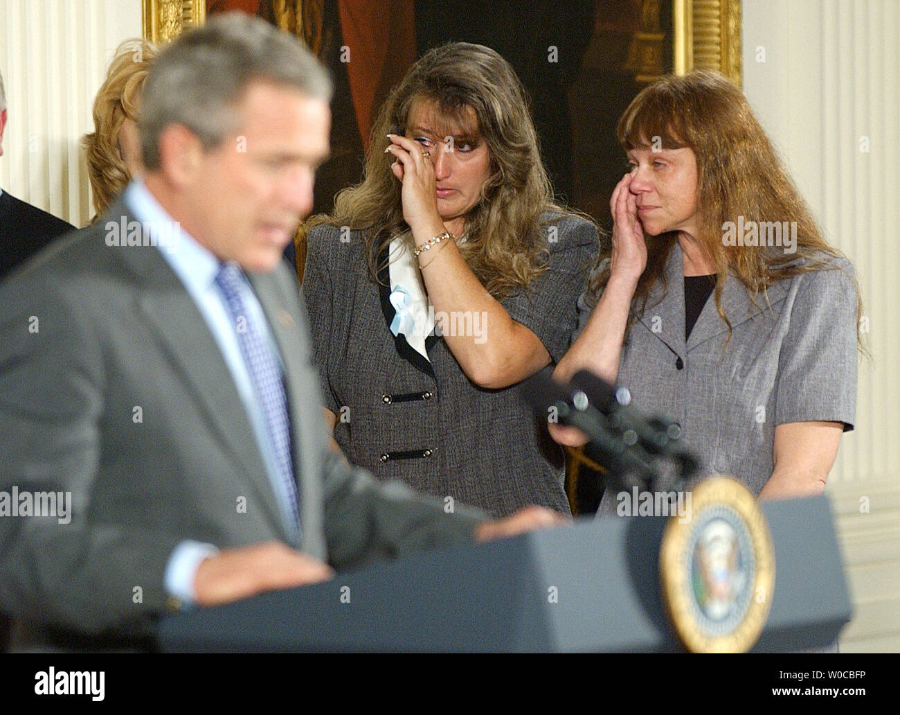 Tracy Marciniak-Seavers and Stephanie Alberts wipe away tears while ...
