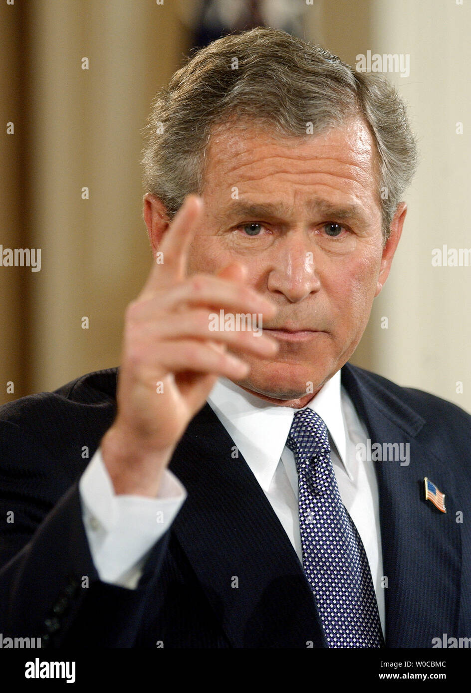 President George W. Bush smiles answers a question from a reporter ...