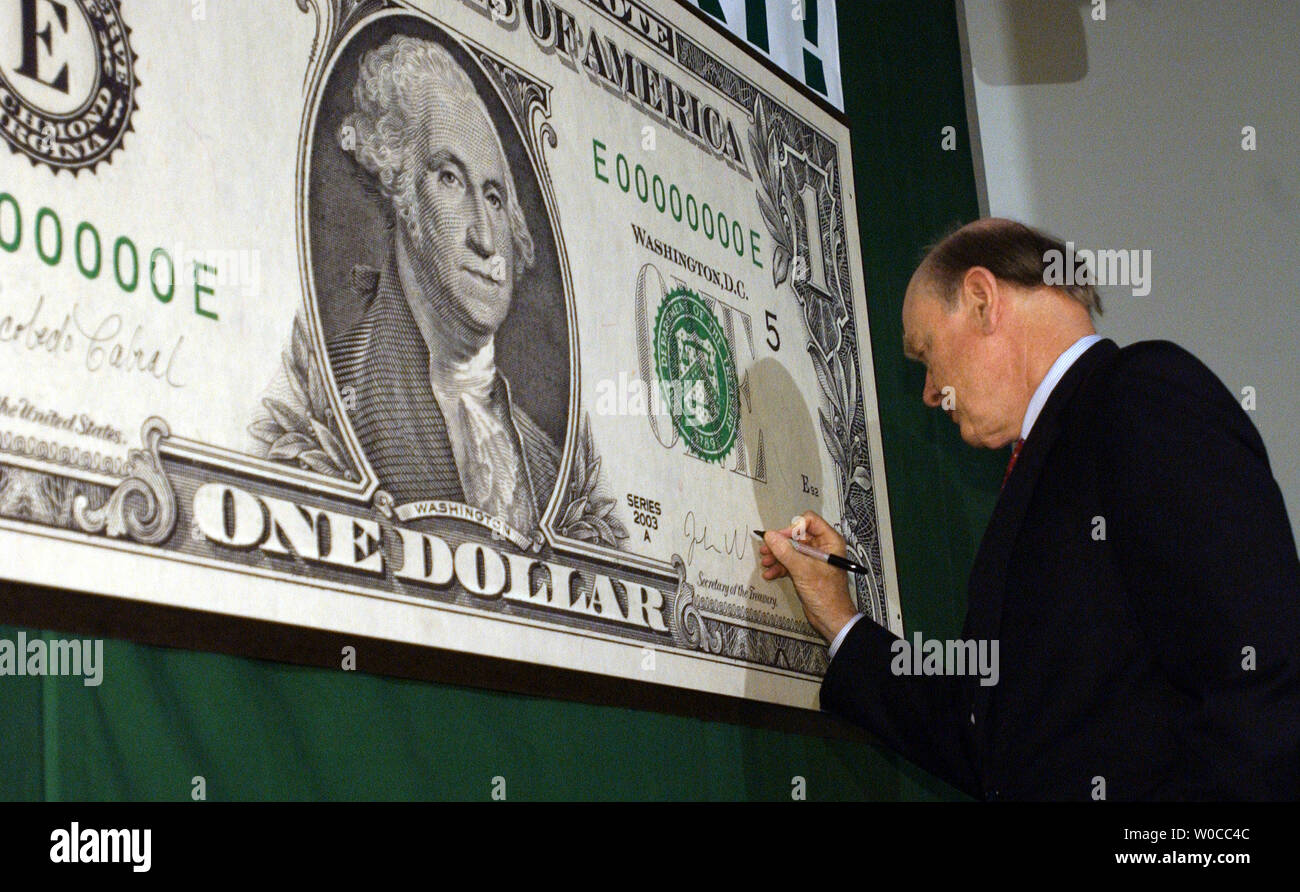Treasury Secretary John W. Snow signs a replica dollar bill at the U.S ...