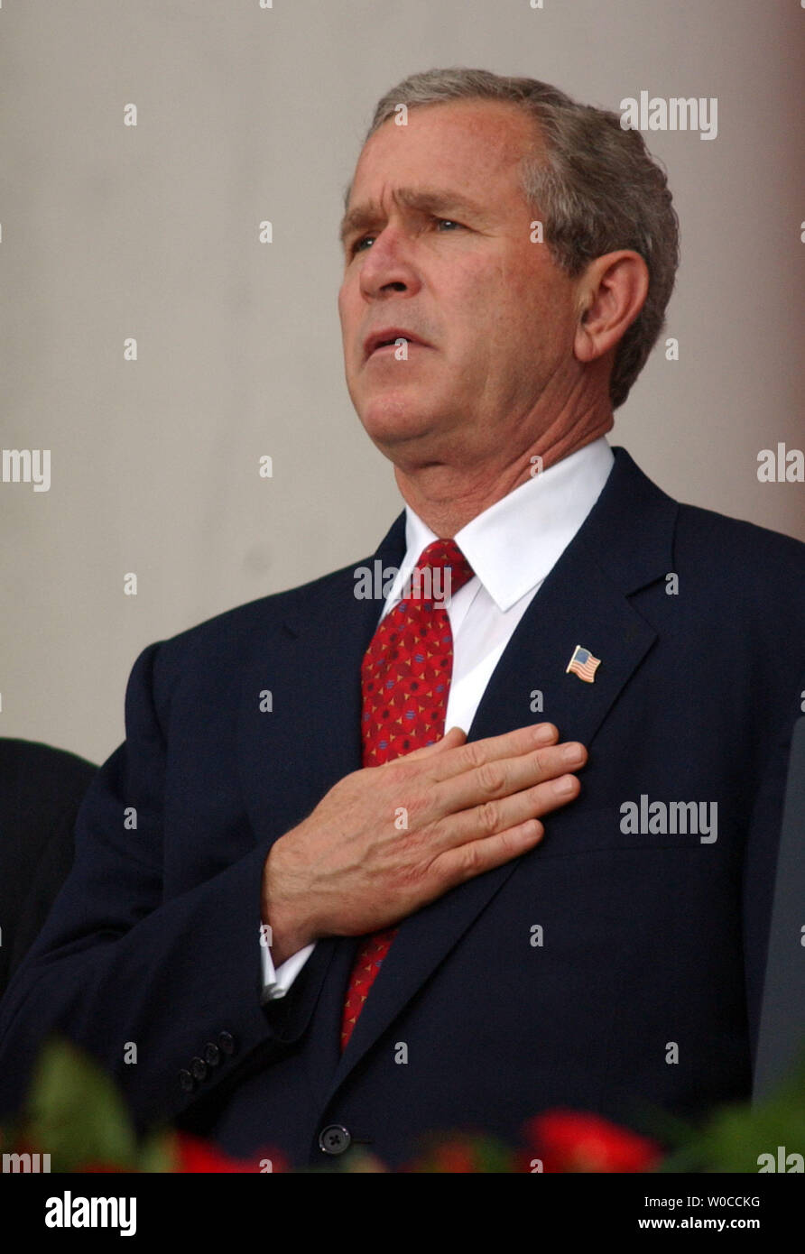 President George W. Bush puts his hand on his heart during the playing ...