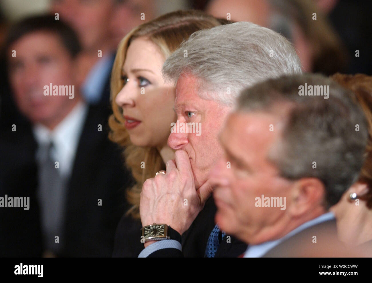 Former President Bill Clinton sits next to President George W. Bush ...