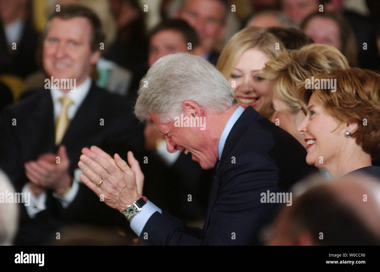 Former President Bill Clinton has a laugh while sitting next to First ...