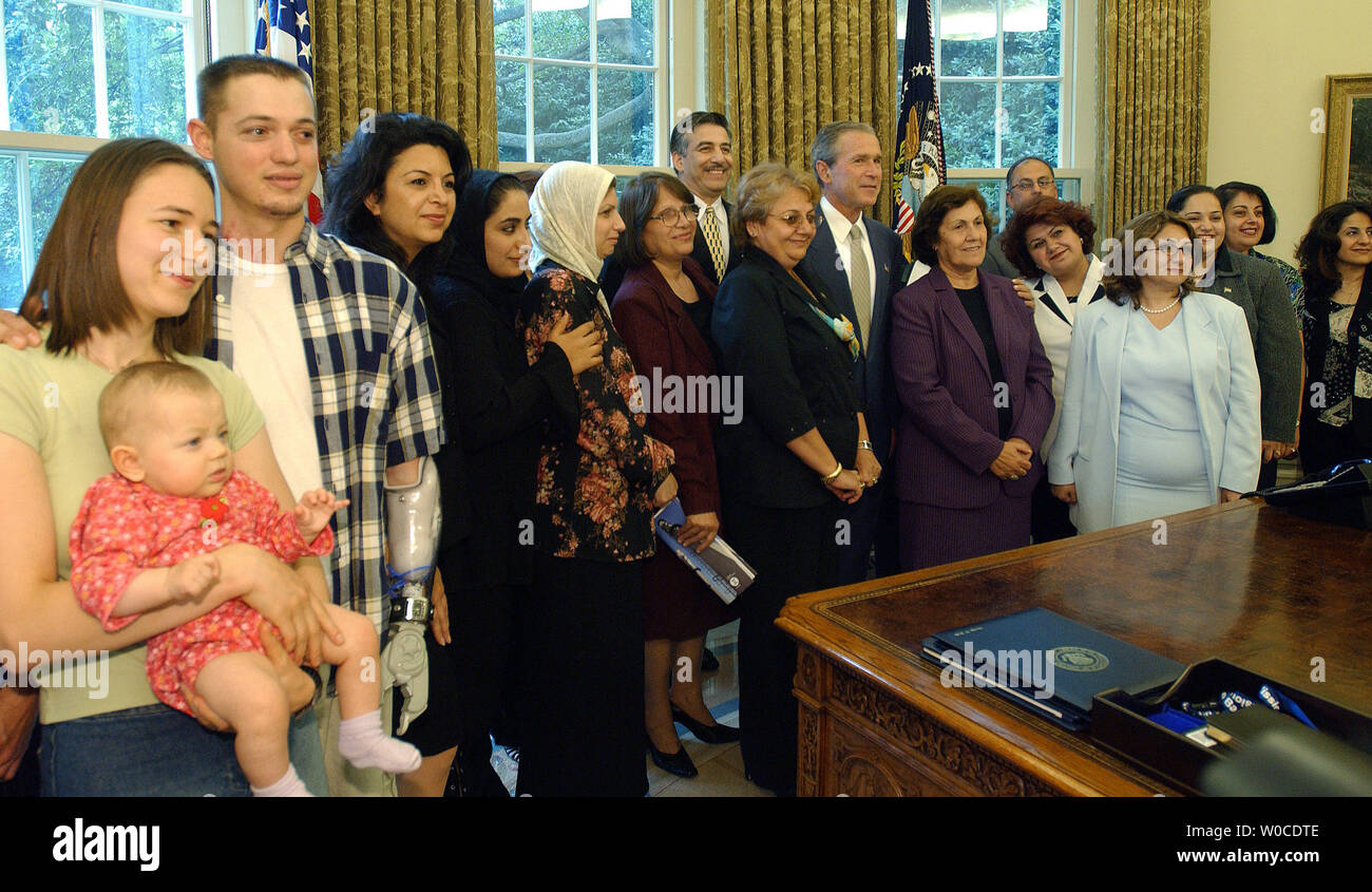 President George W. Bush poses for a picture with Iraqi women and U.S ...