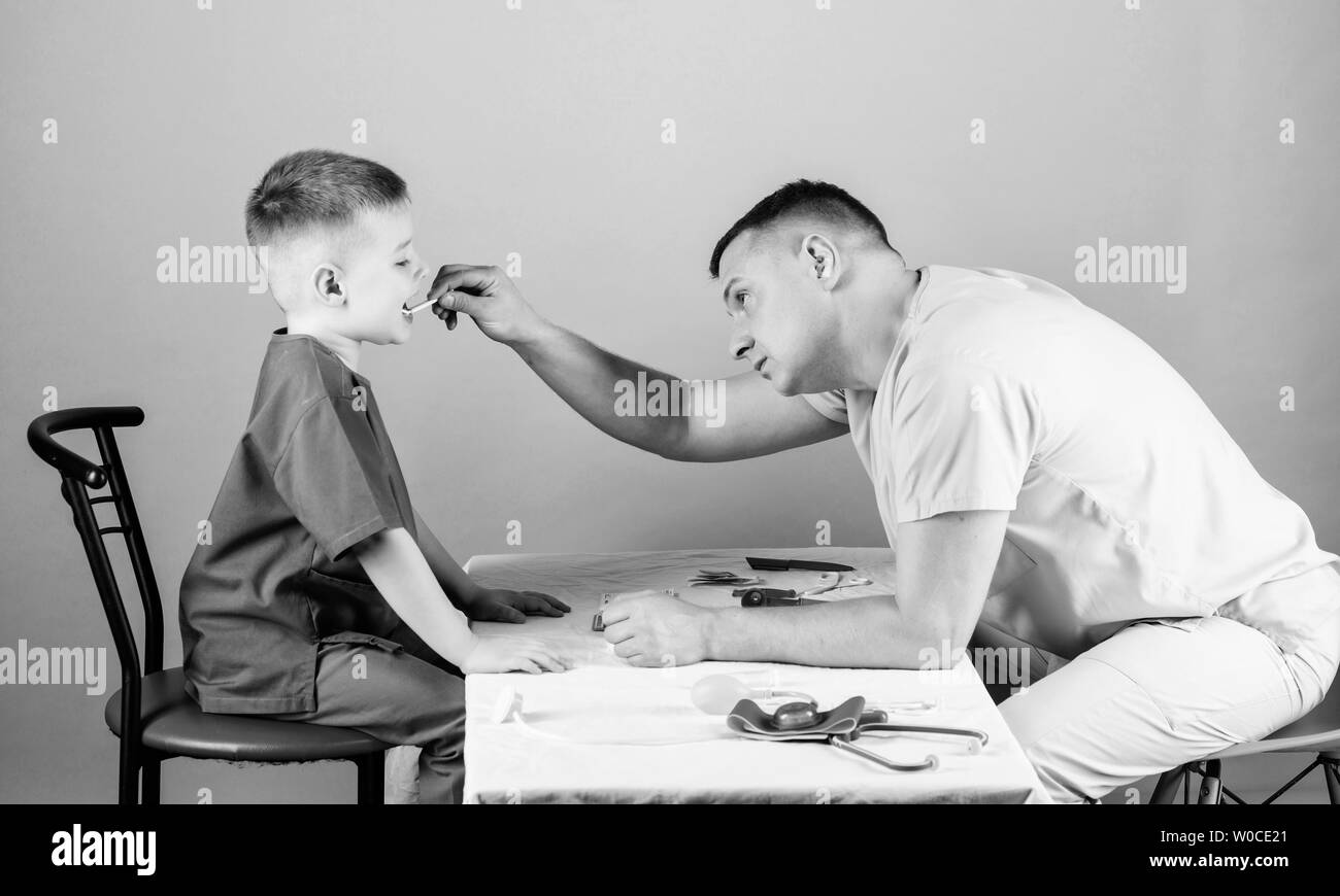 Man doctor sit table medical tools examining little boy patient. Health ...