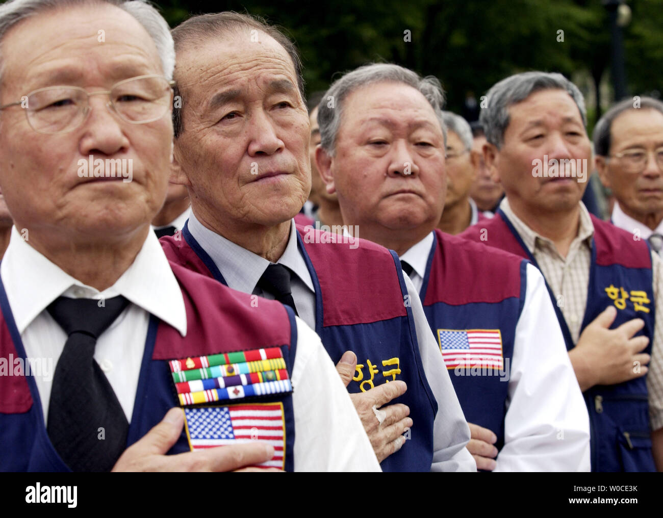 South Korean Veterans take a moment of silence during a ceremony to ...