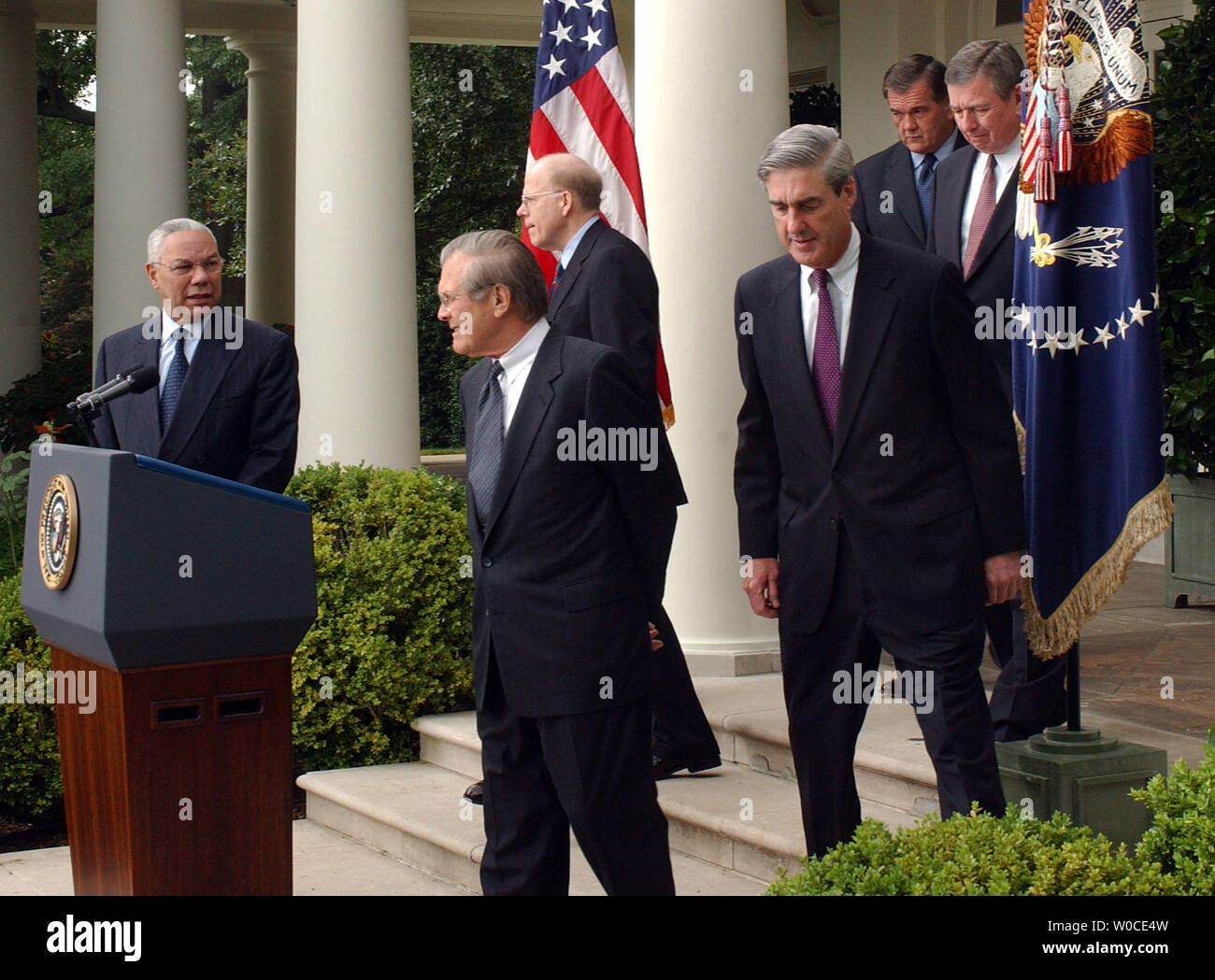 Bush administration officials enter the Rose Garden of the White House ...