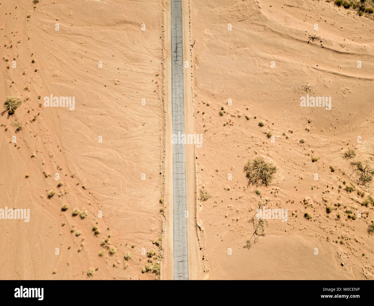 Old Desert road with cracked asphalt, Top down aerial image Stock Photo ...