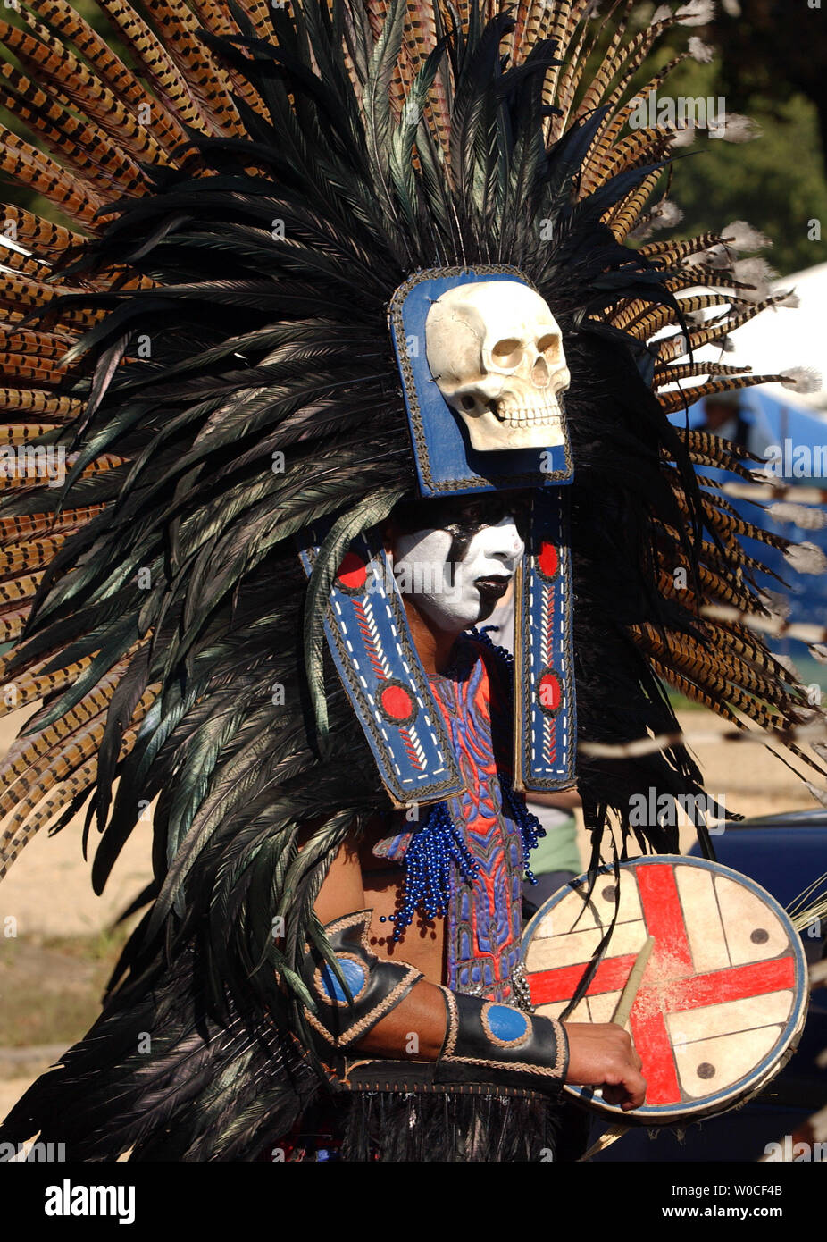 Native Americans wearing traditional Aztec garb parade down the ...