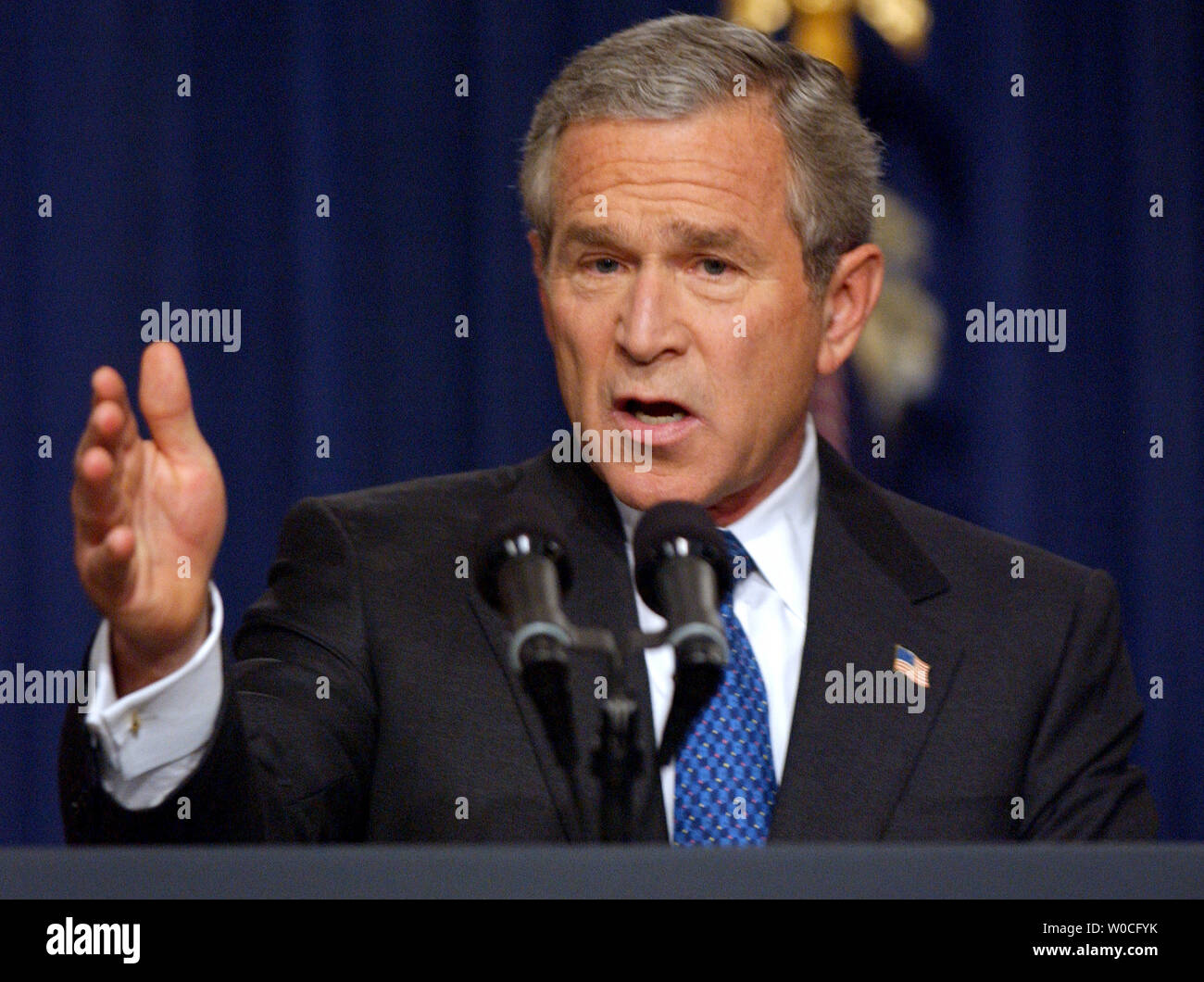 President George W. Bush responds to a question from a reporter during ...