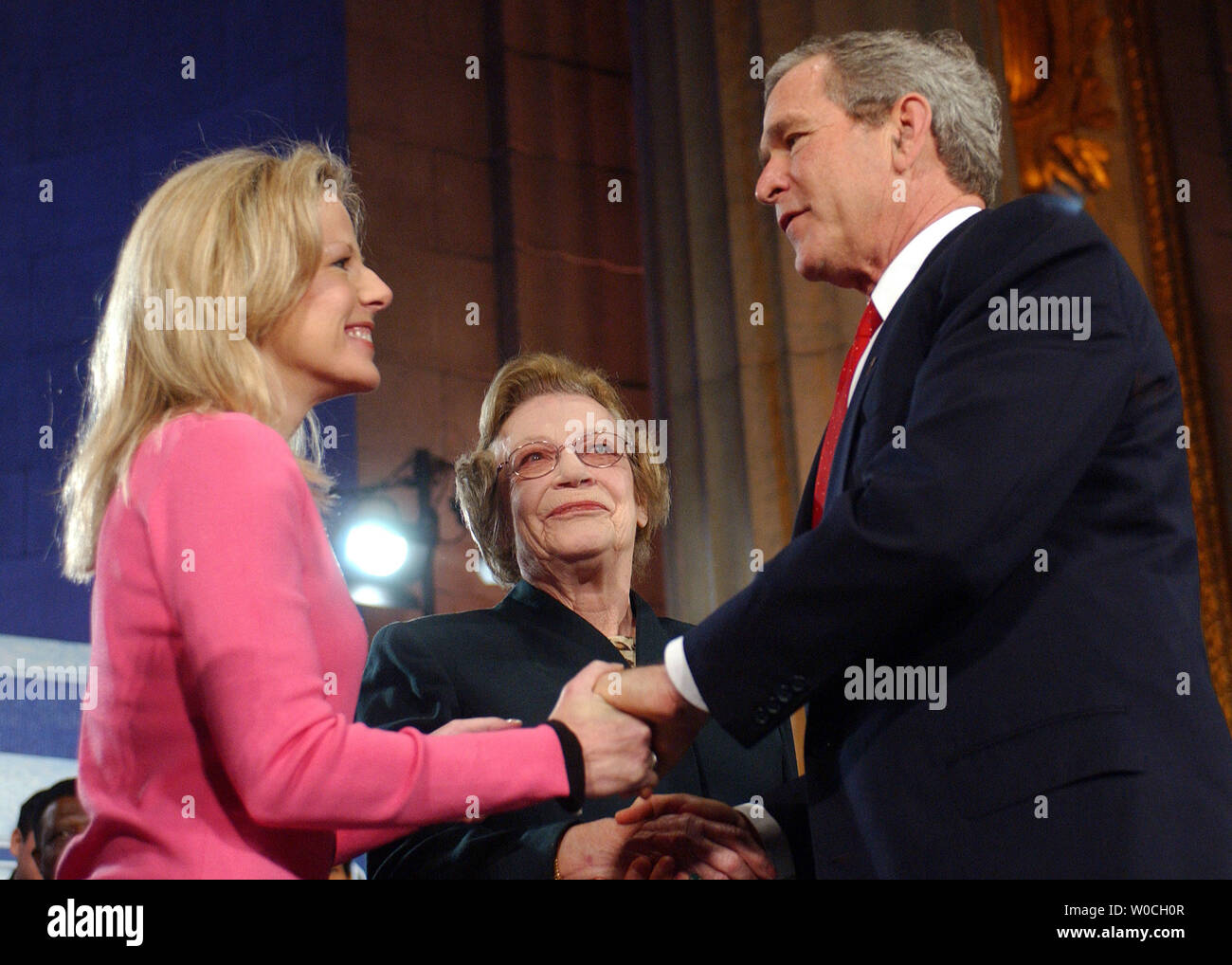 U.S. President George W. Bush shakes hands with Sonya (l) and her ...