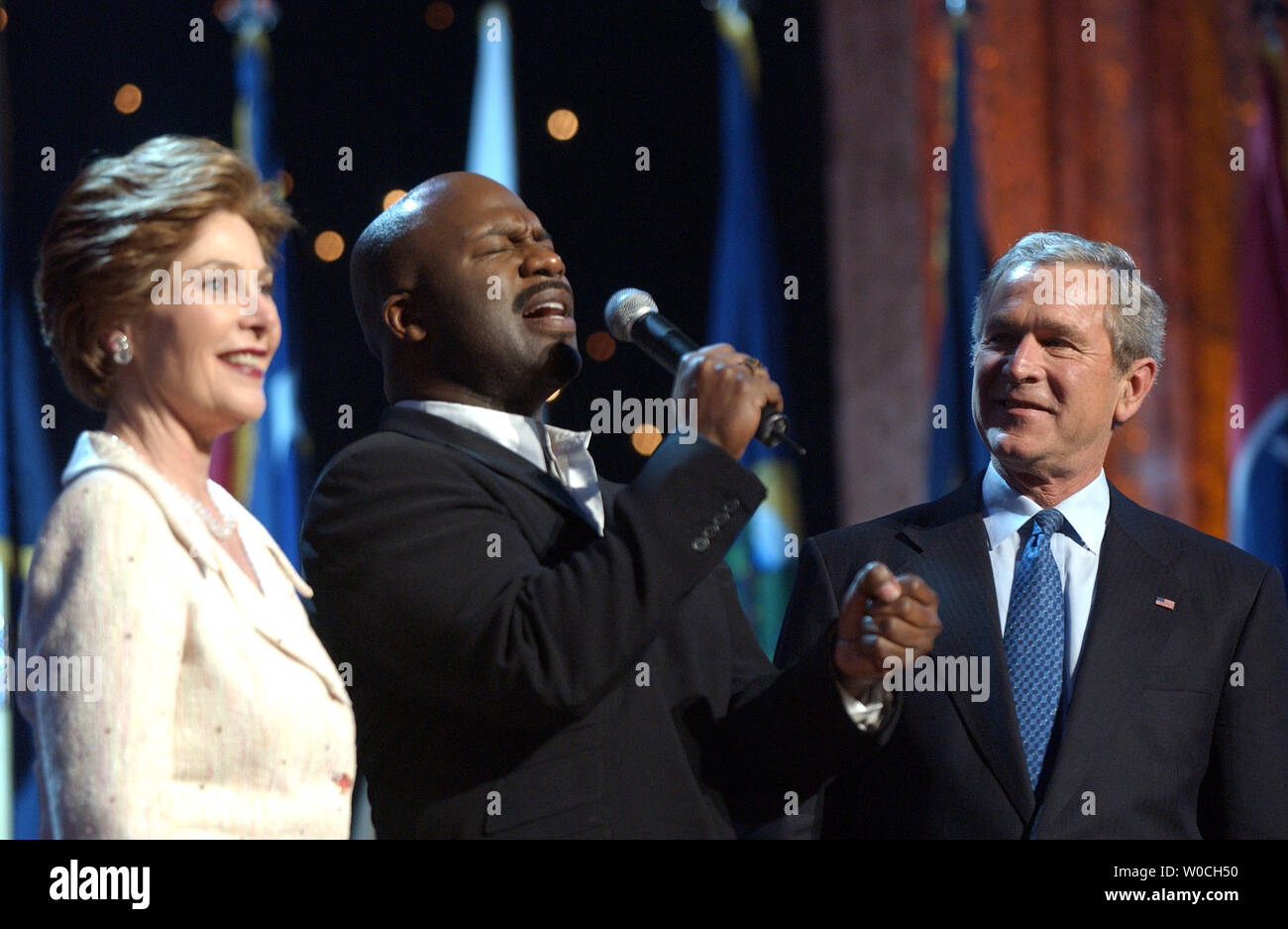 President George W. Bush and First Lady Laura Bush listen as singer ...