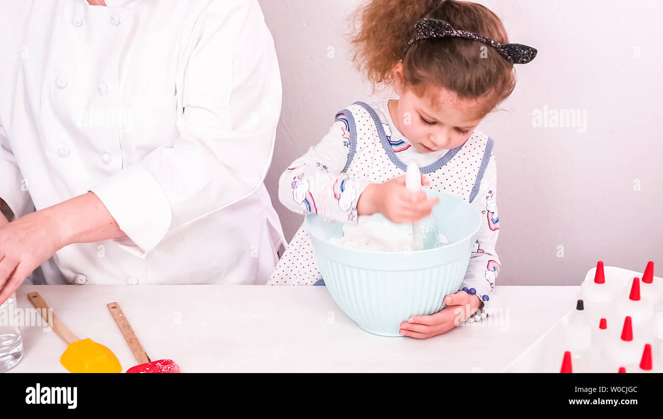 Step by step. Mixing royal icing to decorate sugar cookies Stock Photo ...