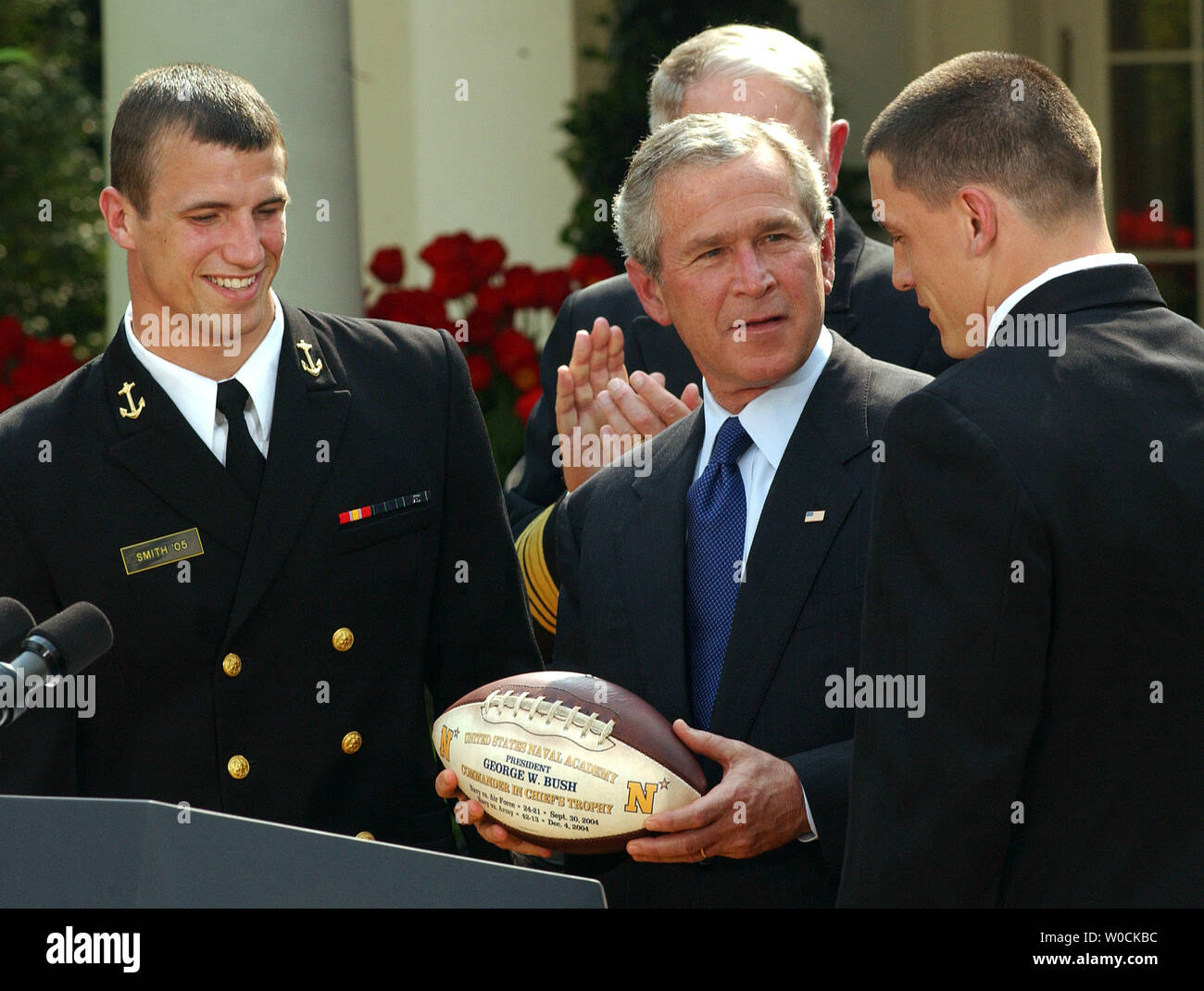 U.S. President George W. Bush recieves a football from U.S. Naval ...
