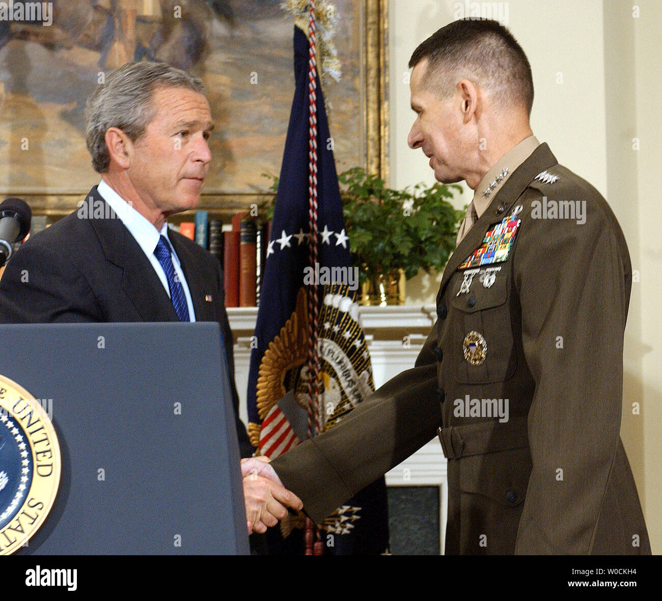 U.S. President George W. Bush shakes hands with Marine Gen. Peter Pace ...