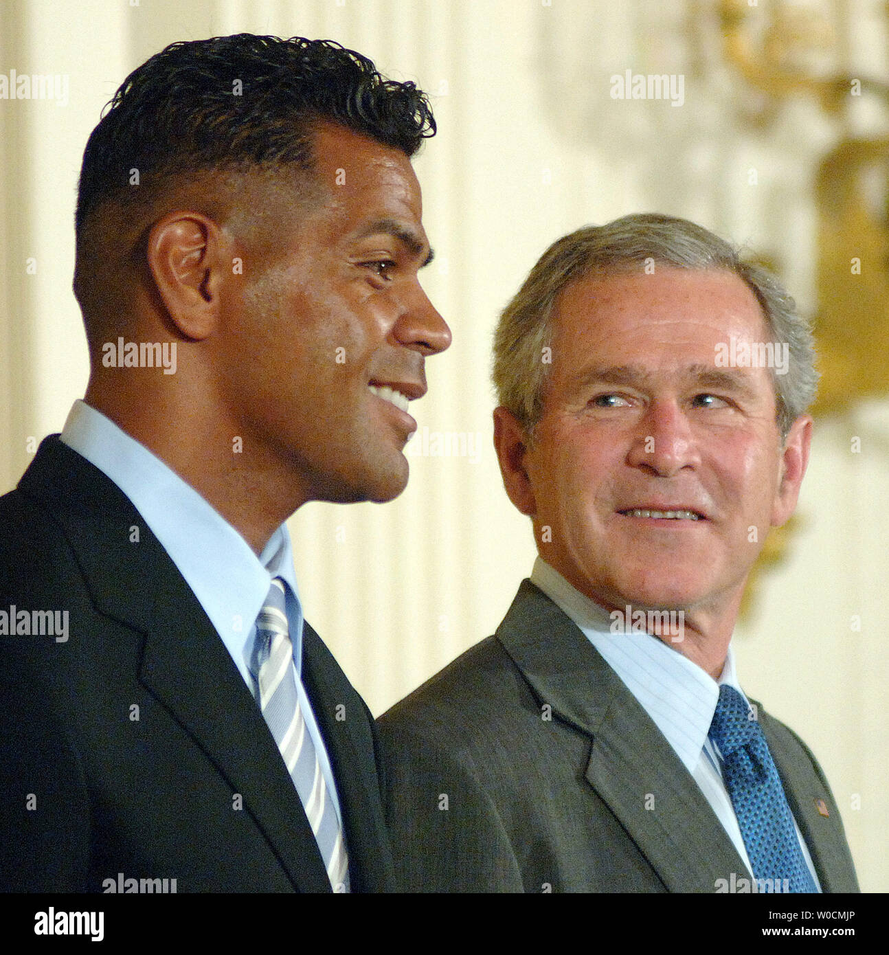 U.S. President George W. Bush stands with NFL player Junior Seau during ...