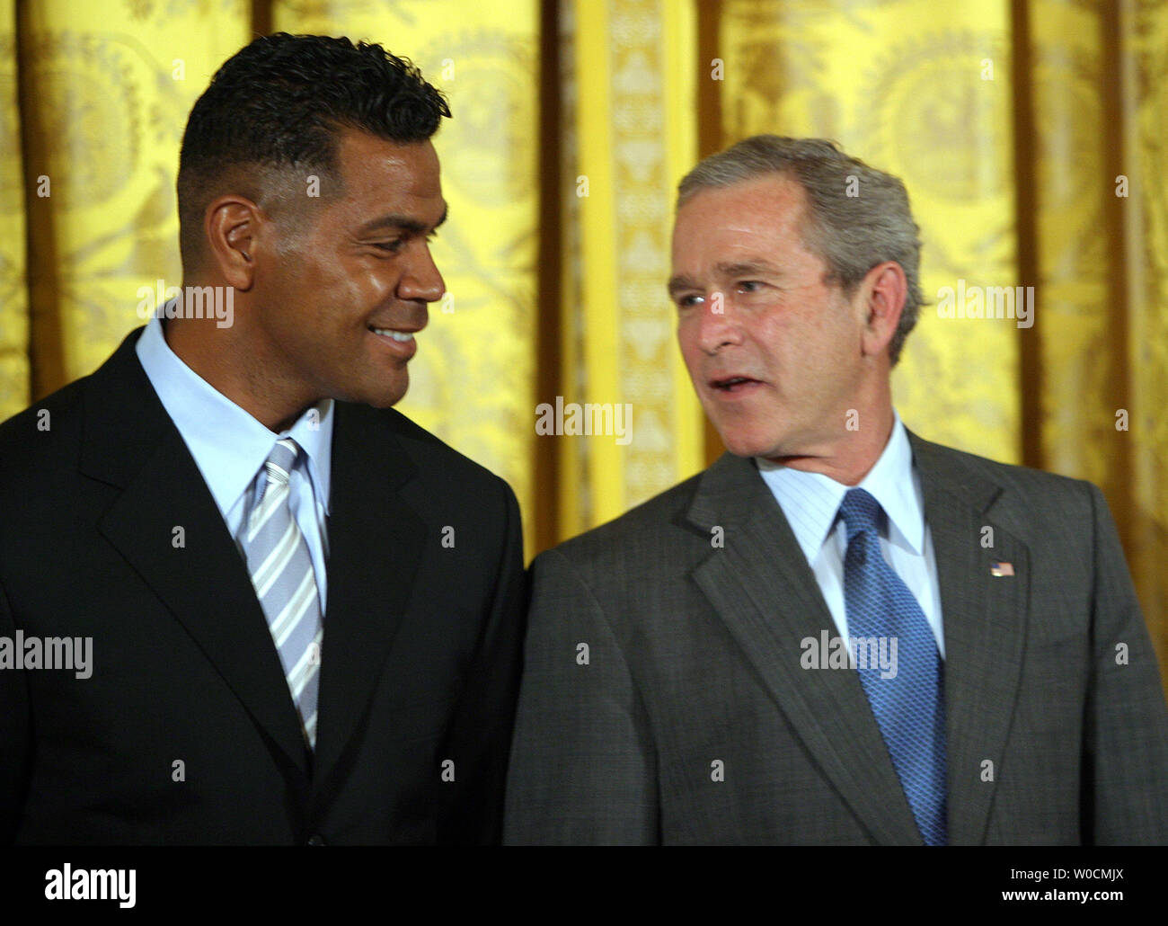 U.S. President George W. Bush stands with NFL player Junior Seau during ...