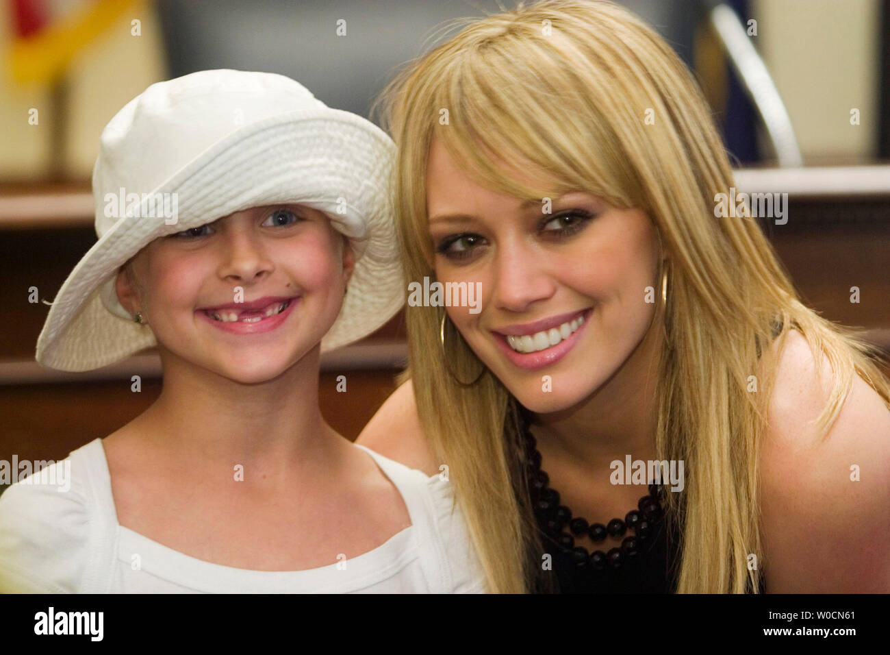 Actress Hilary Duff smiles as she meets children during a visit to ...