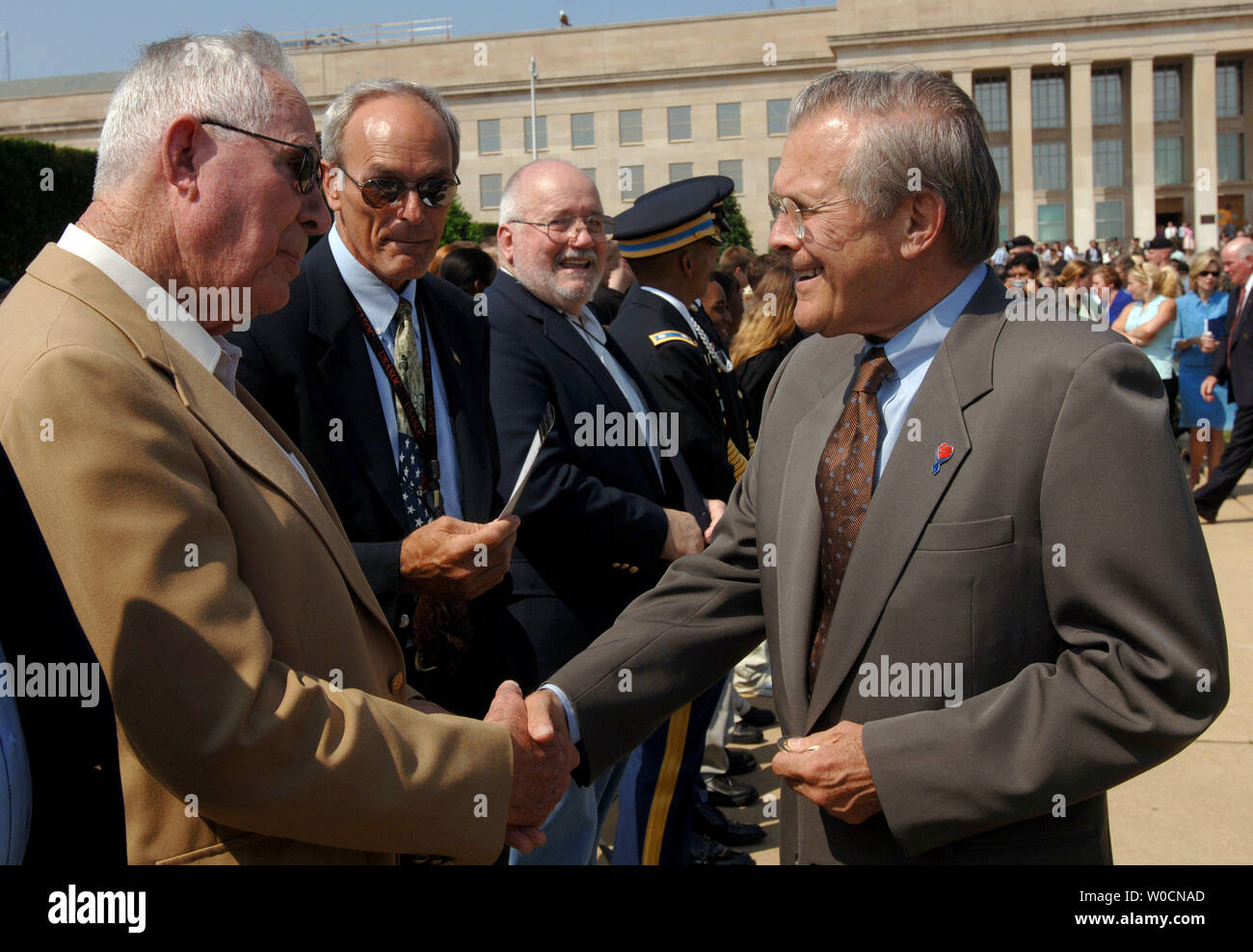 Secretary of Defense Donald Rumsfeld shakes hands with retired Army ...
