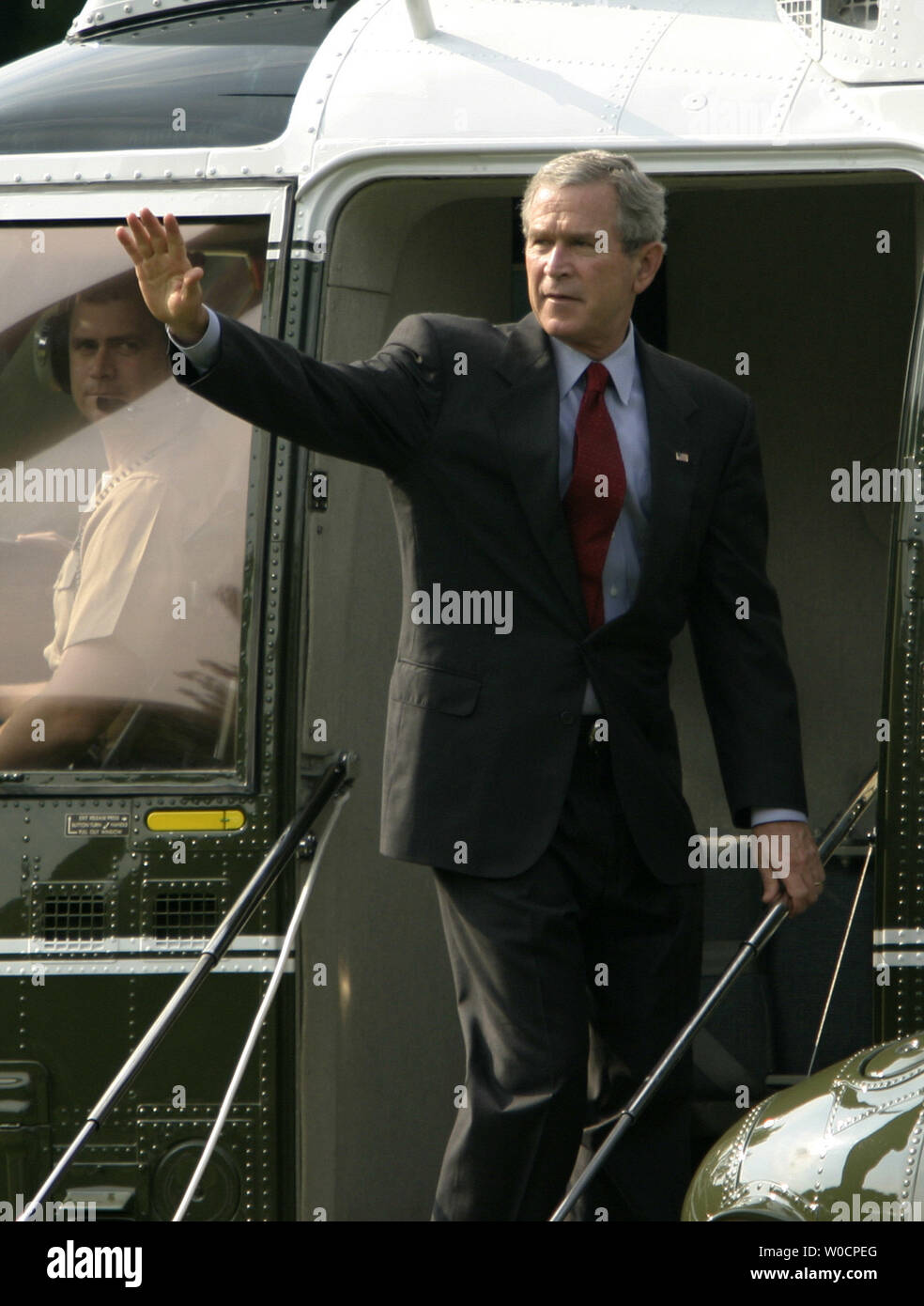 President George Bush waves as he boards Marine One for a day trip to ...
