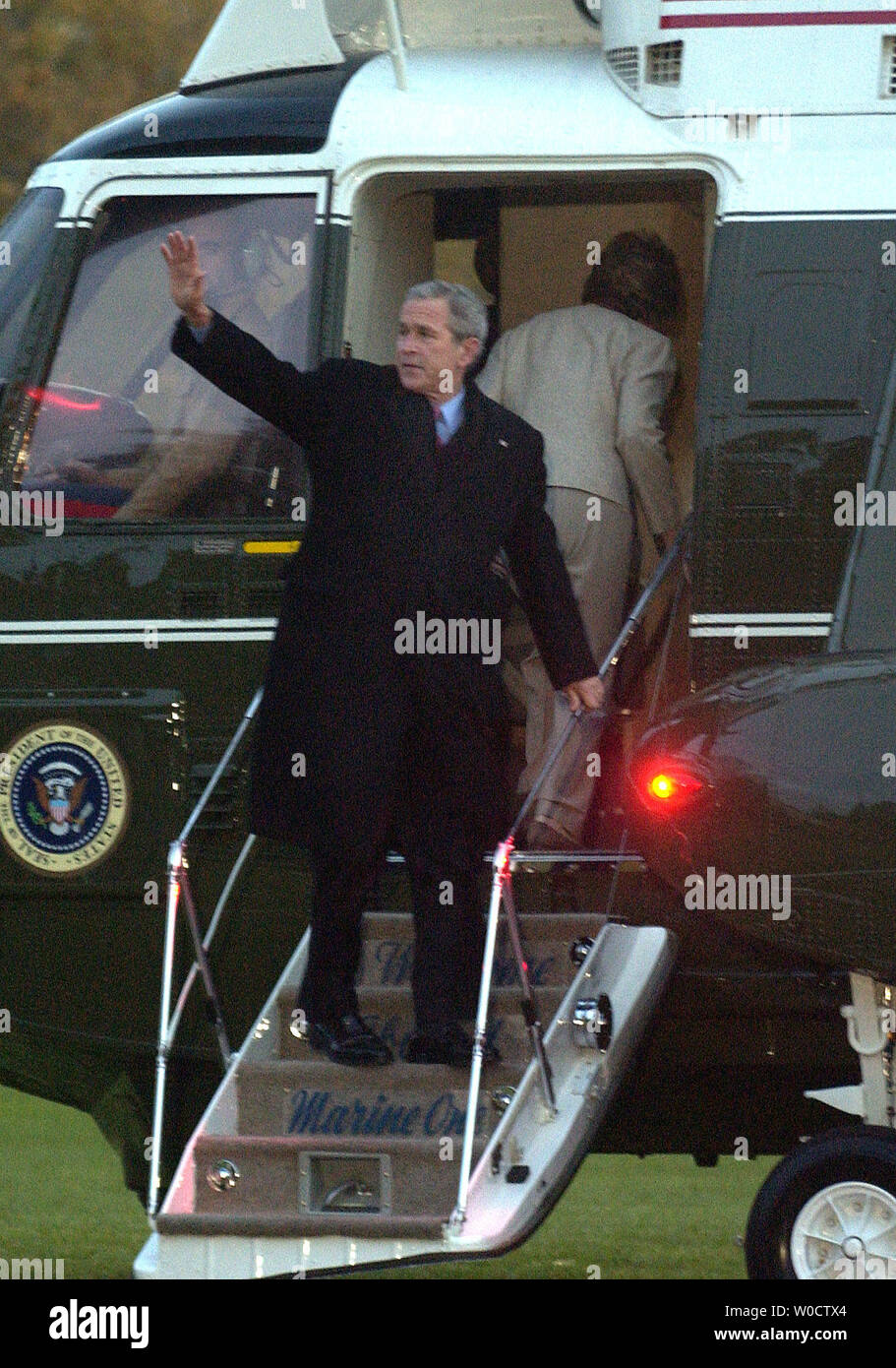 President George W. Bush waves as he steps on to Marine 1, as he and ...