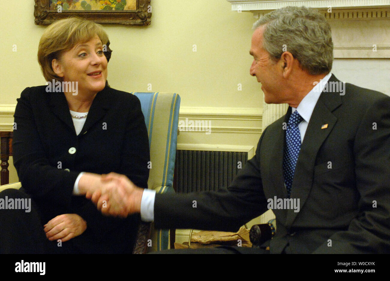 U.S. President George W. Bush shakes hands with German Chancellor ...