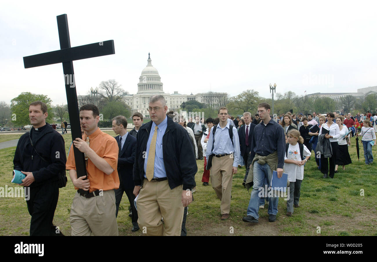 Mike Riconscente carries a cross as he leads fellow Christians during ...