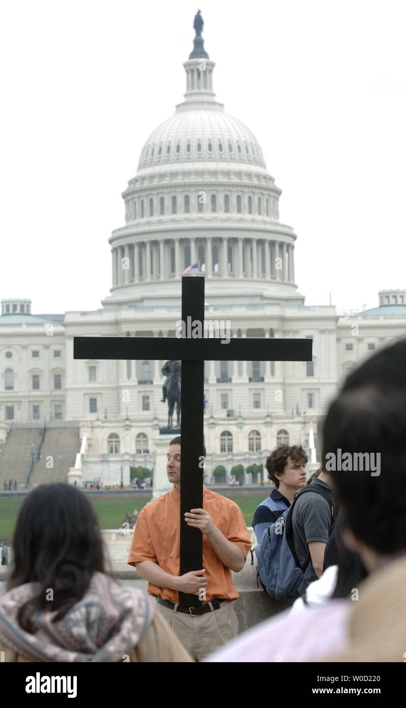 Mike Riconscente holds a cross as he and fellow Christians prey in fron ...