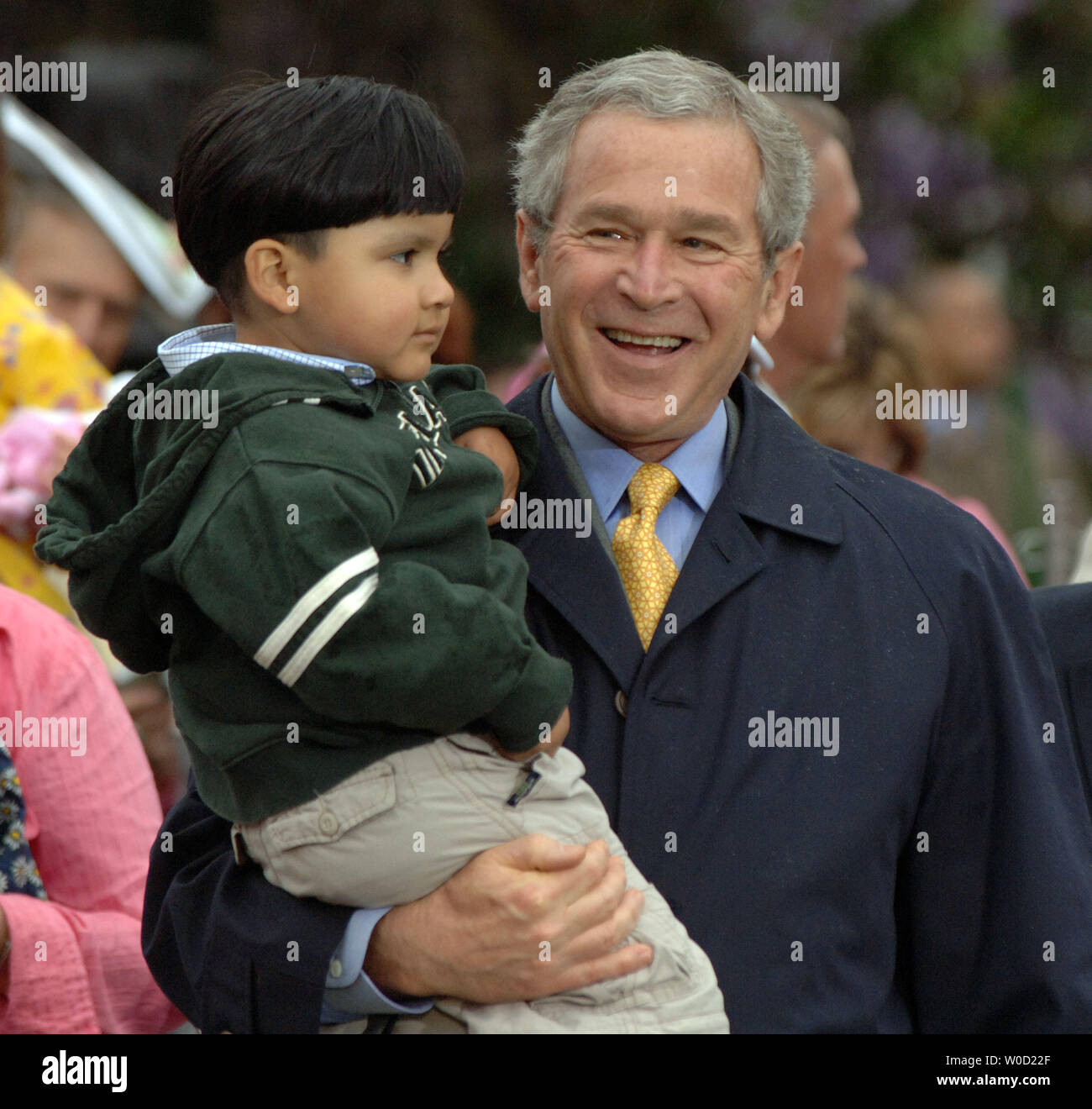 U.S. President George W. Bush holds Benjamin Favela as children roll ...