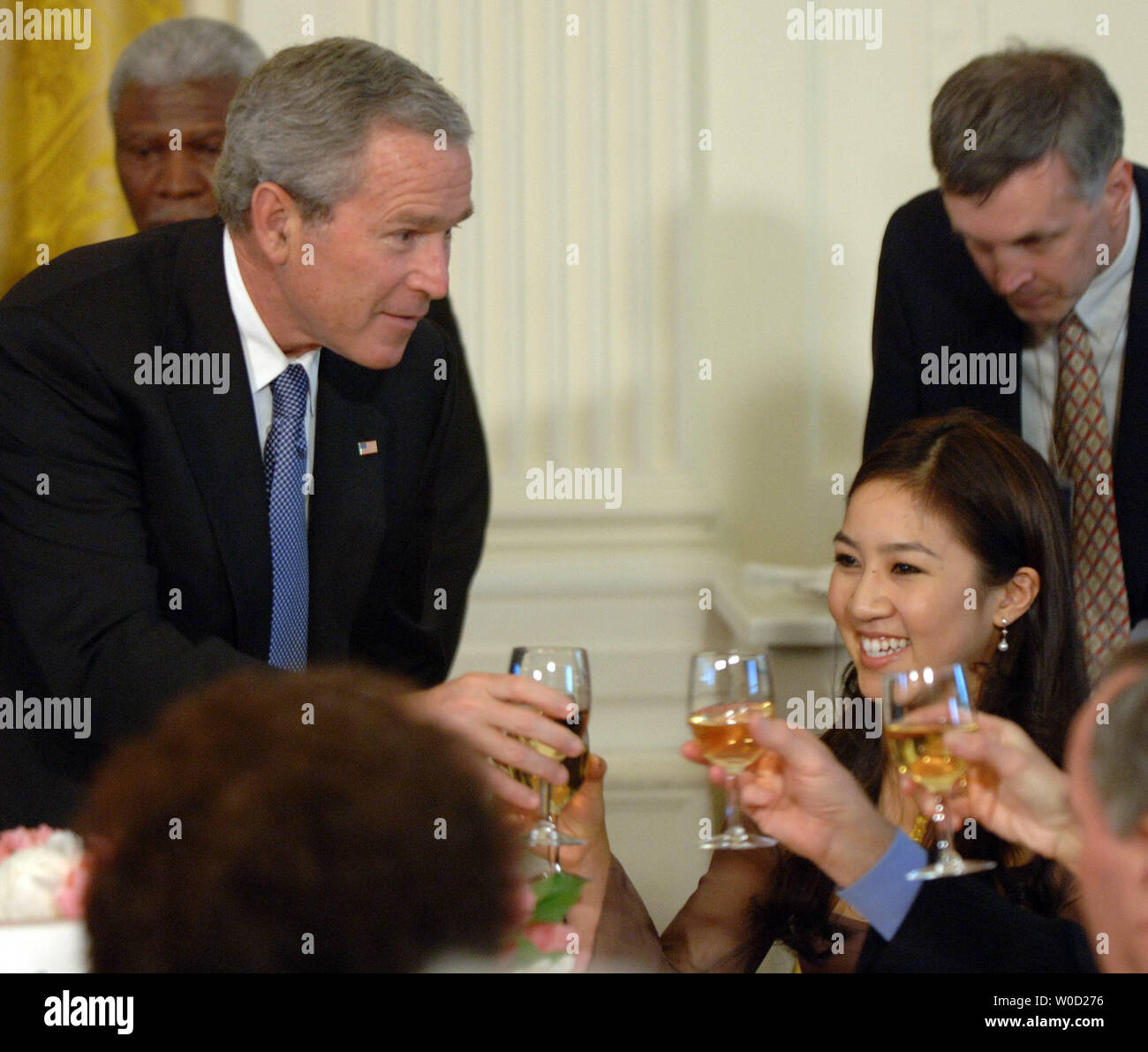 U.S. President George W. Bush toasts figure skater Michelle Kwan during ...