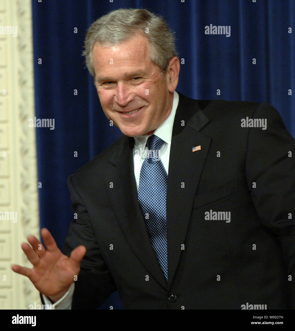 U.S. President George W. Bush waves after meeting with recipients of ...