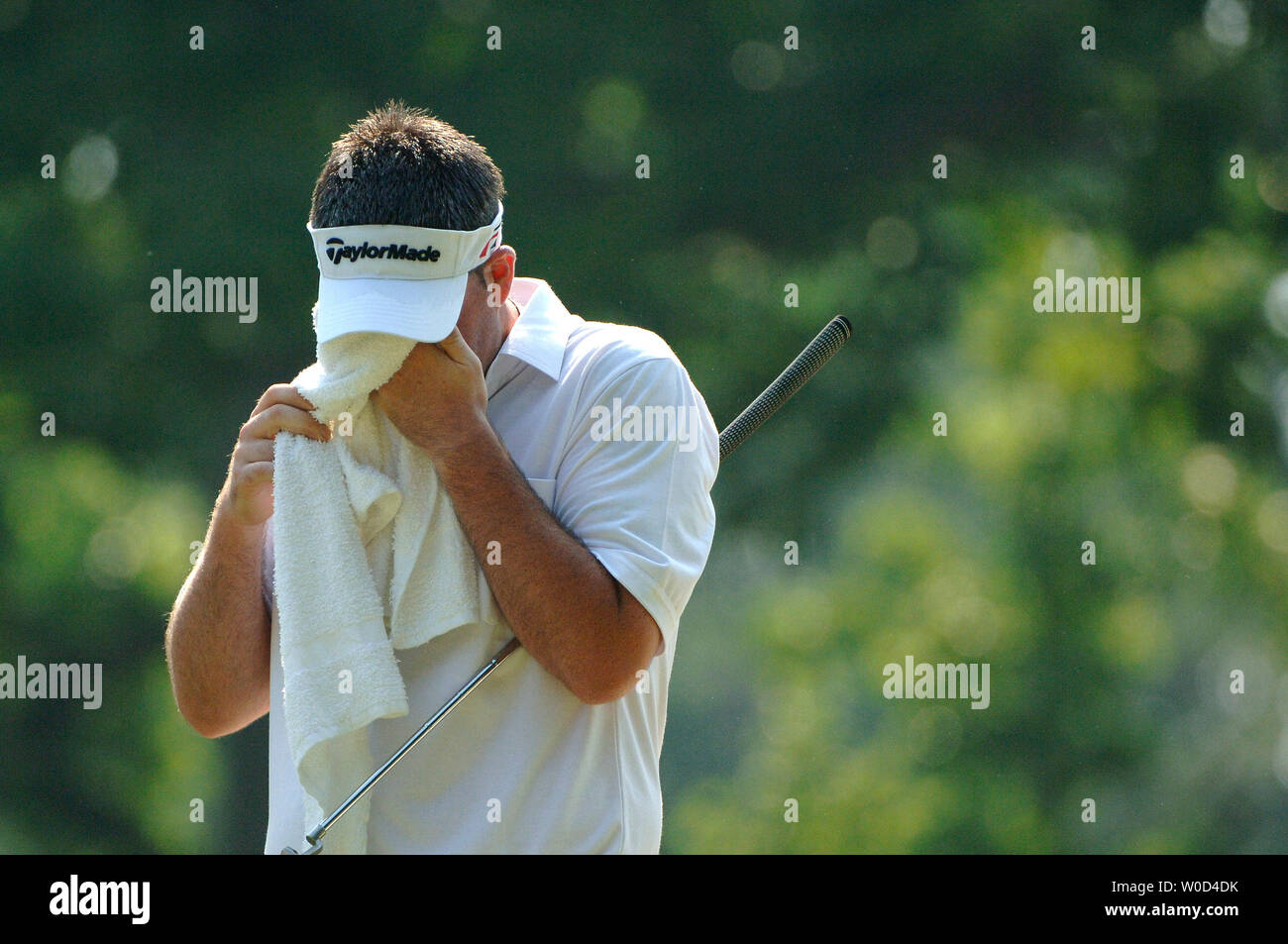 Kenneth Ferrie wipes sweat from his face on the fifth green, during the ...
