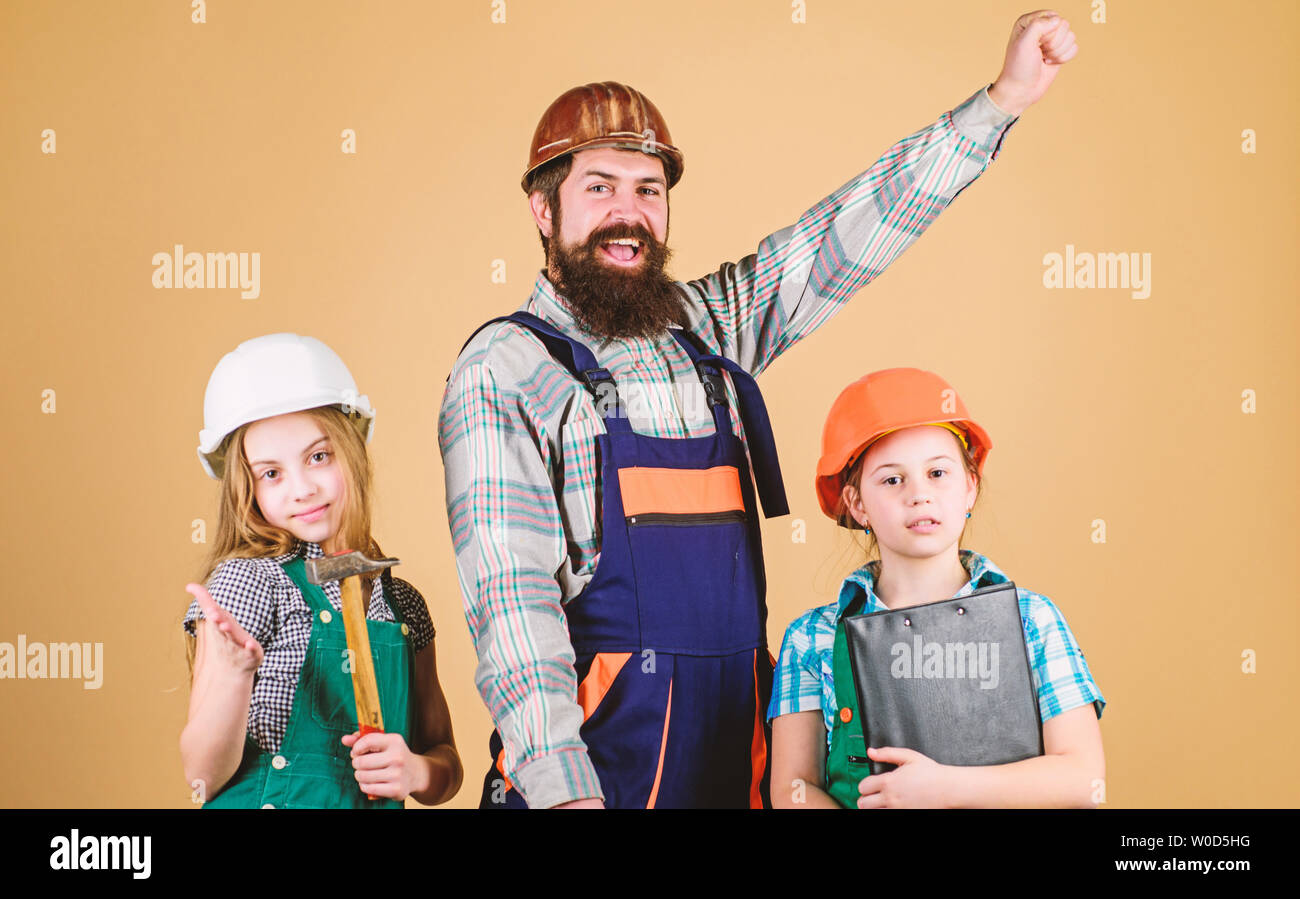 Dream team. Father builder and kids girls repair home. Teach daughter ...