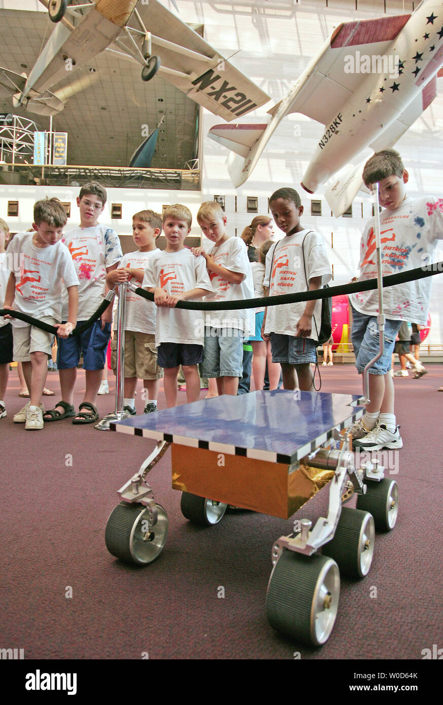 Children watch a Mars rover make its way through an obstacle course at ...