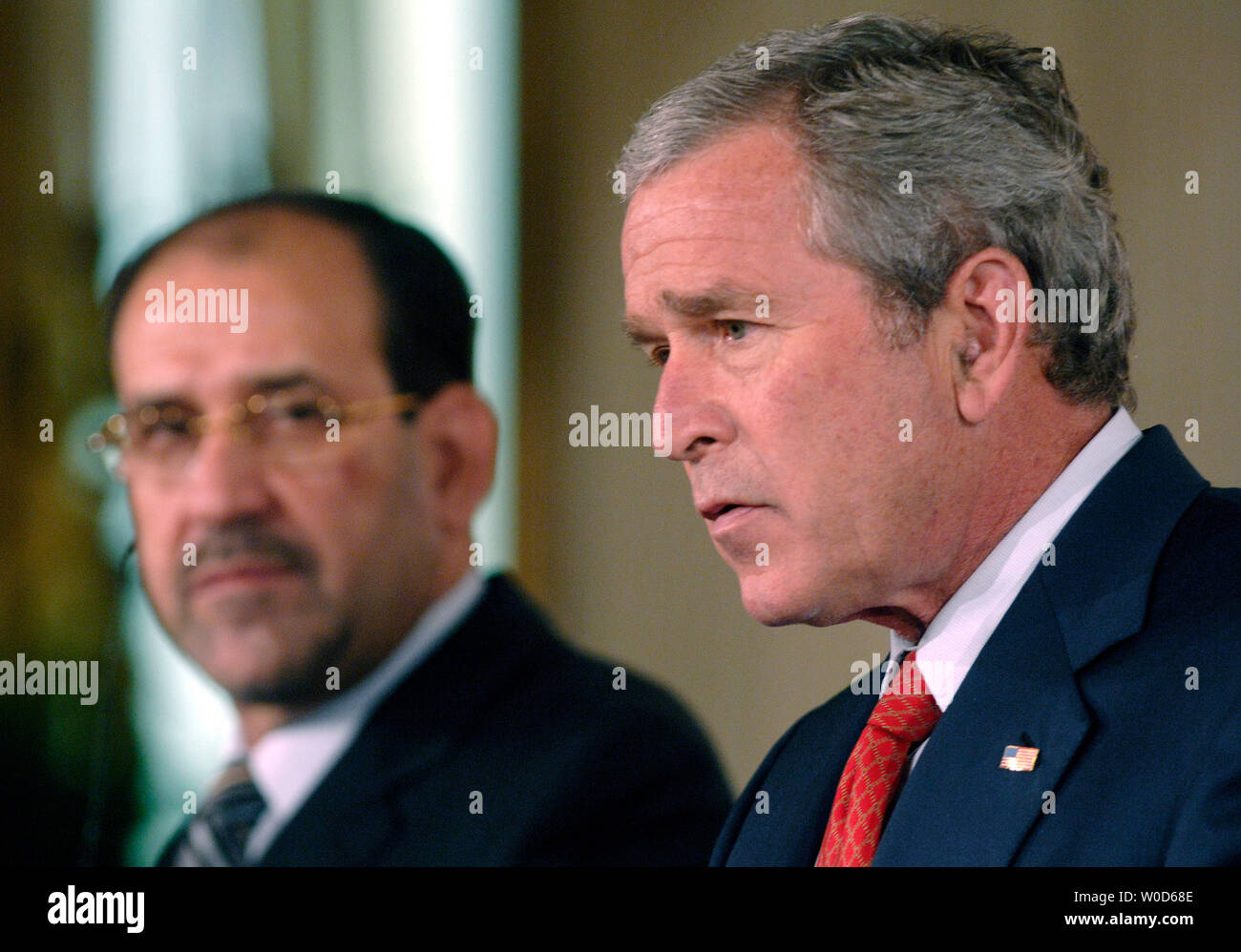 President George W Bush R Speaks Alongside The Iraqi Prime Minister