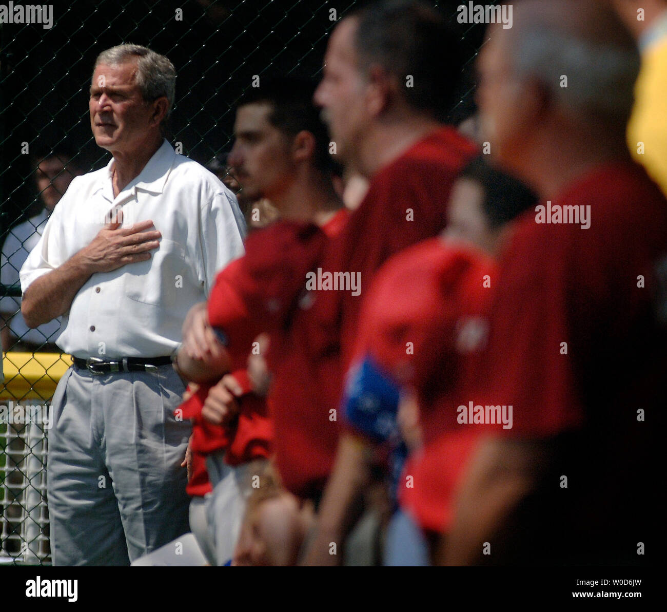 President George W. Bush stands for the singing of the National Anthem ...