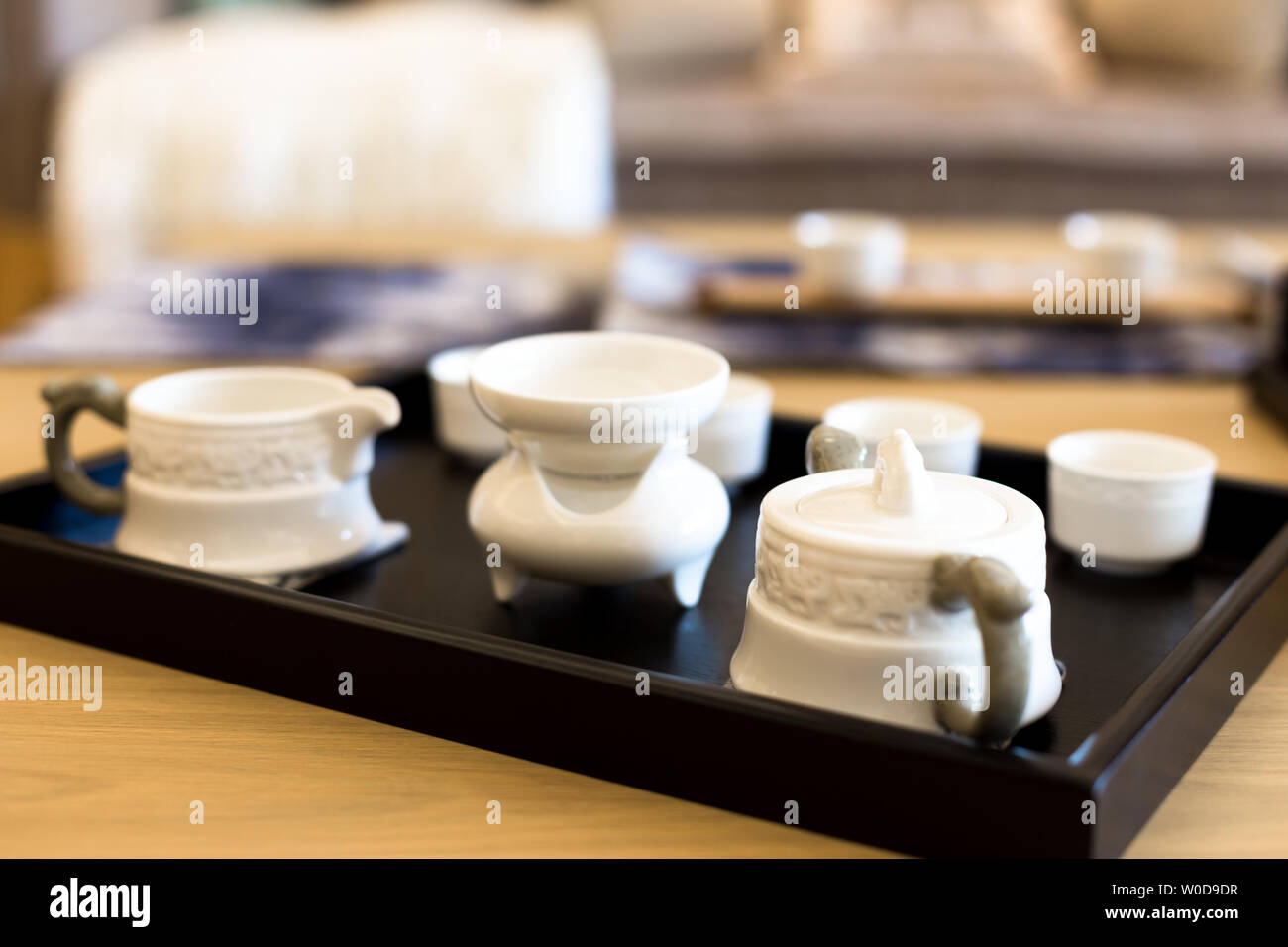 elegant ceramic tea sets on table in modern living room Stock Photo - Alamy