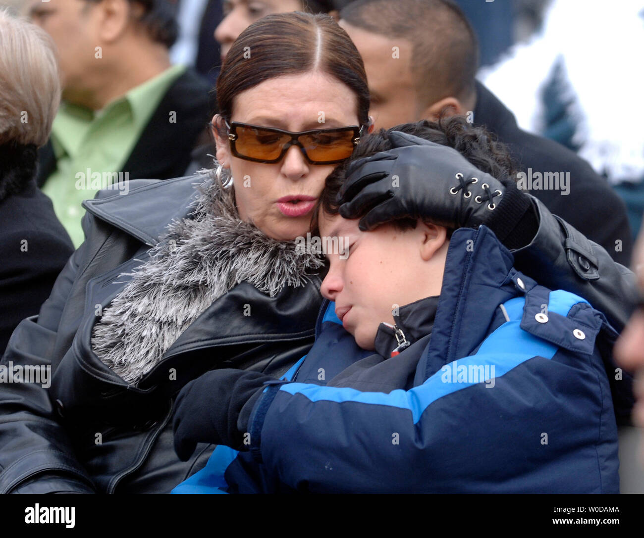 Kerry Flick consoles her son, Sage, during an anniversary ceremony ...