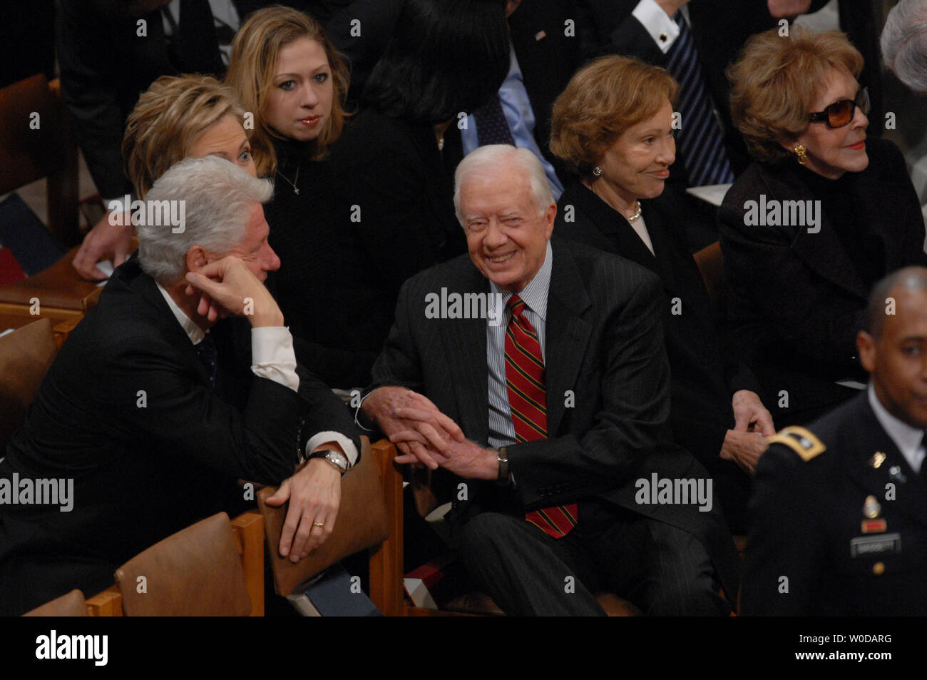 Former President Jimmy Carter (R) chats former President Bill Clinton ...