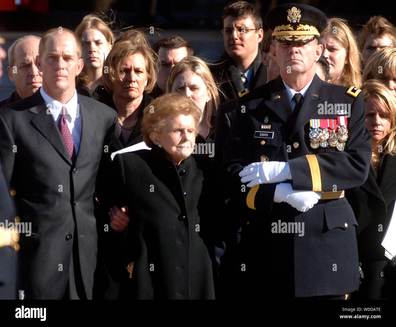 The widow of former President Gerald Ford, Betty Ford (C), is escorted ...
