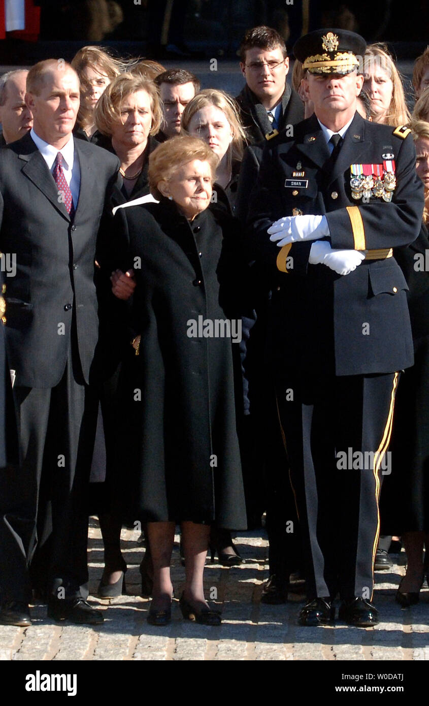 The widow of former President Gerald Ford, Betty Ford (C), is escorted ...