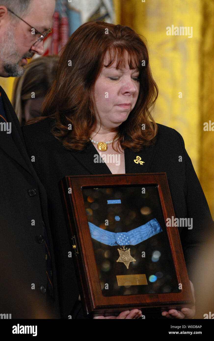 Deb Dunham speaks with her husband Dan during a Medal of Honor ceremony ...