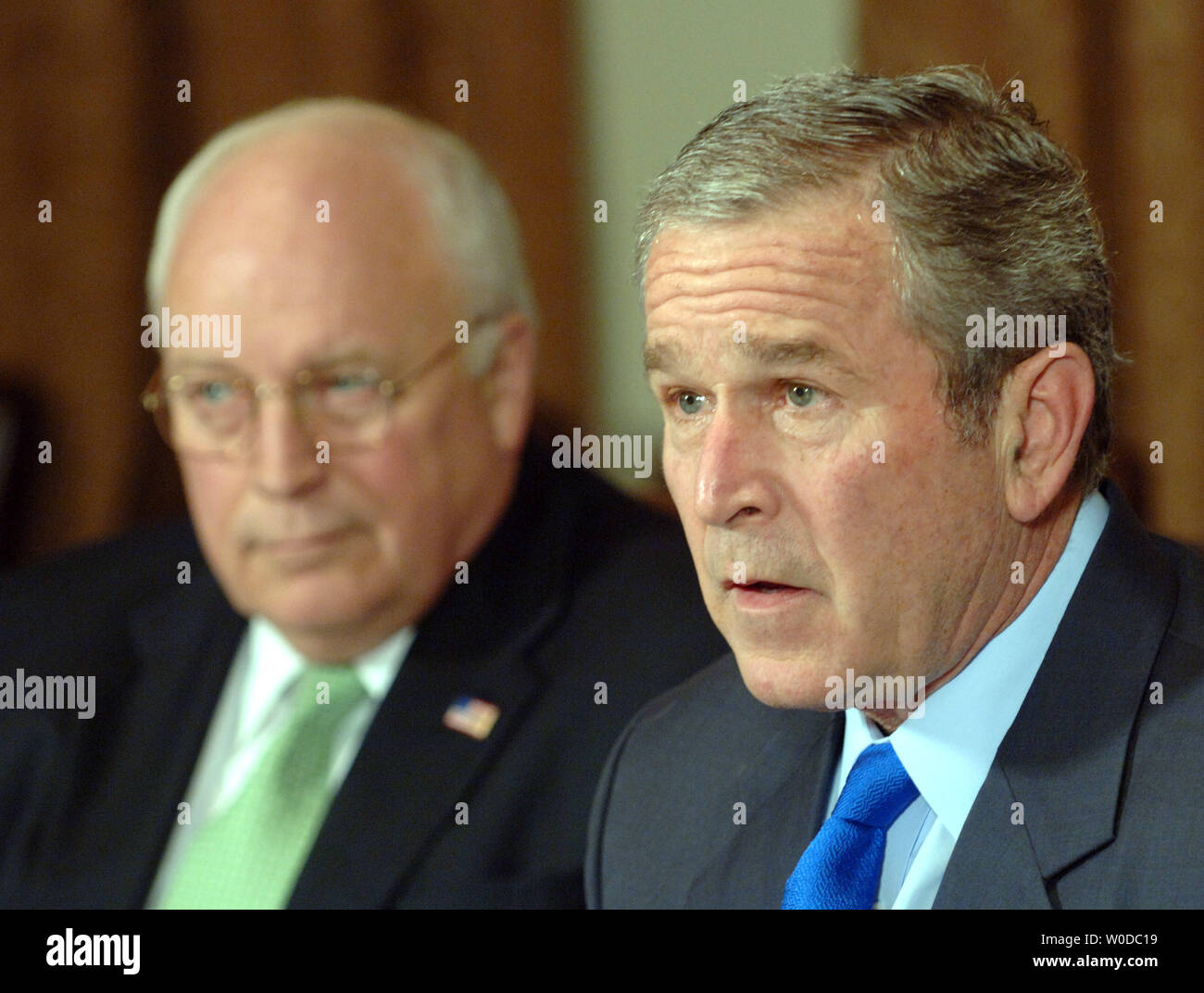 Vice President Dick Cheney (L) listens as U.S. President George W. Bush ...