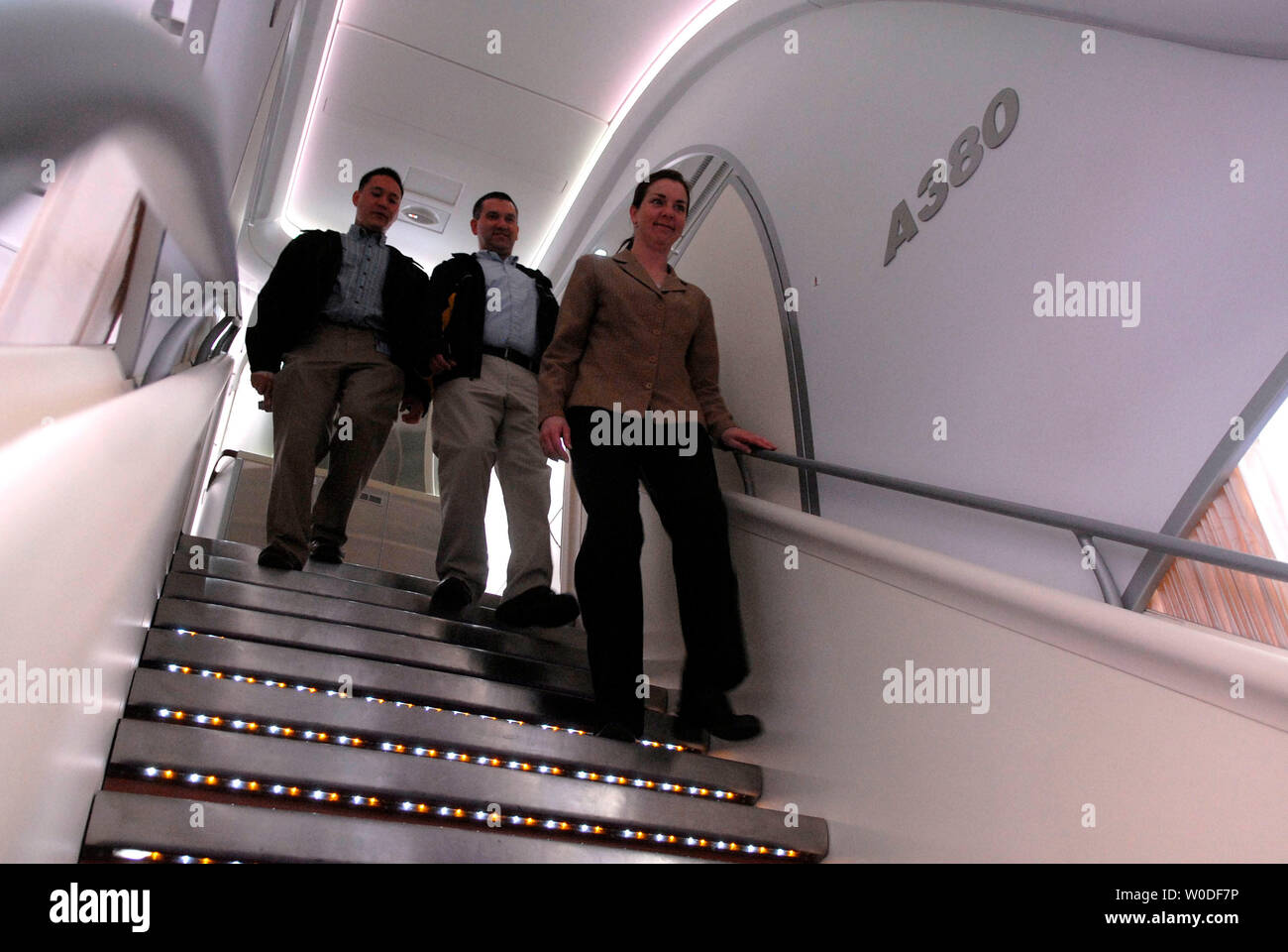 Tour participants descend the front staircase of the Airbus A380 ...