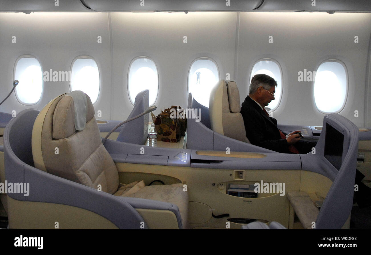 A tour participant tests out the first class seating section of the ...