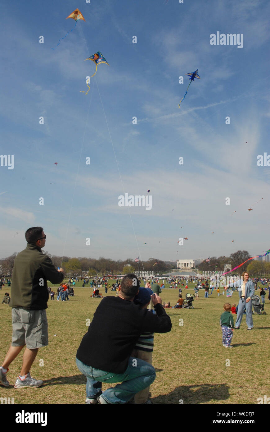 Steve Scavitto (C) and his 4 year old son, Nicolas, fly a kite during ...