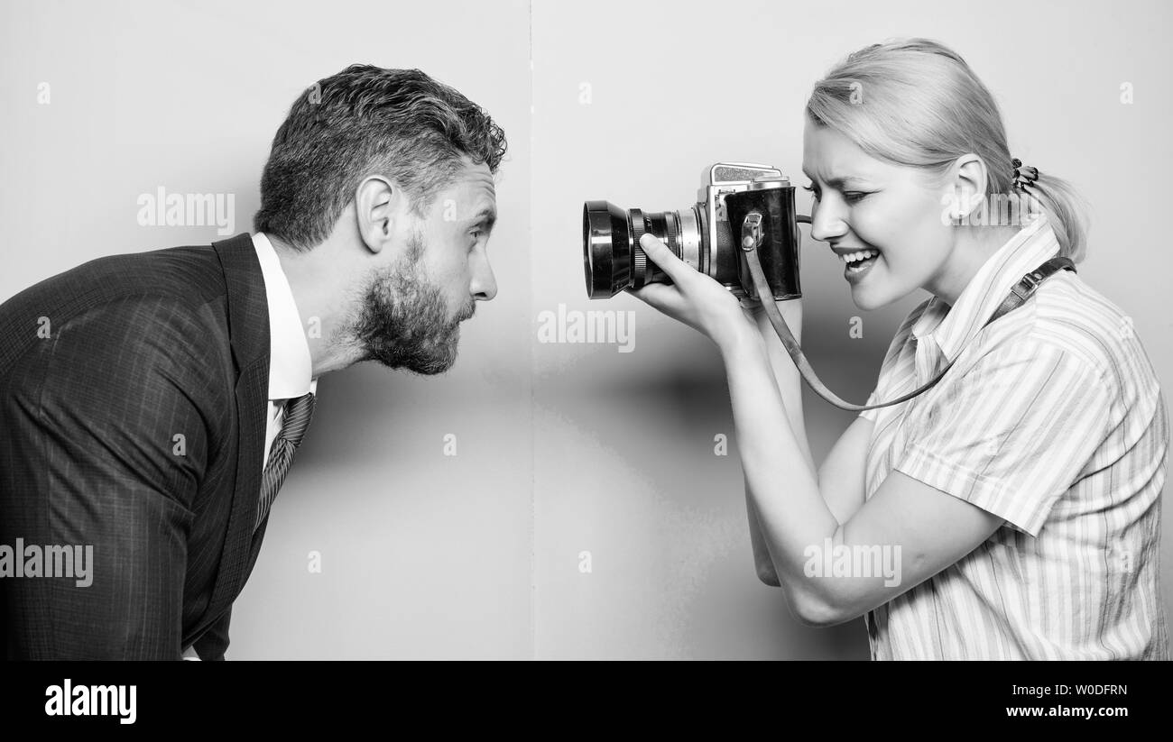 He is photogenic. Pretty woman using professional camera. Businessman ...