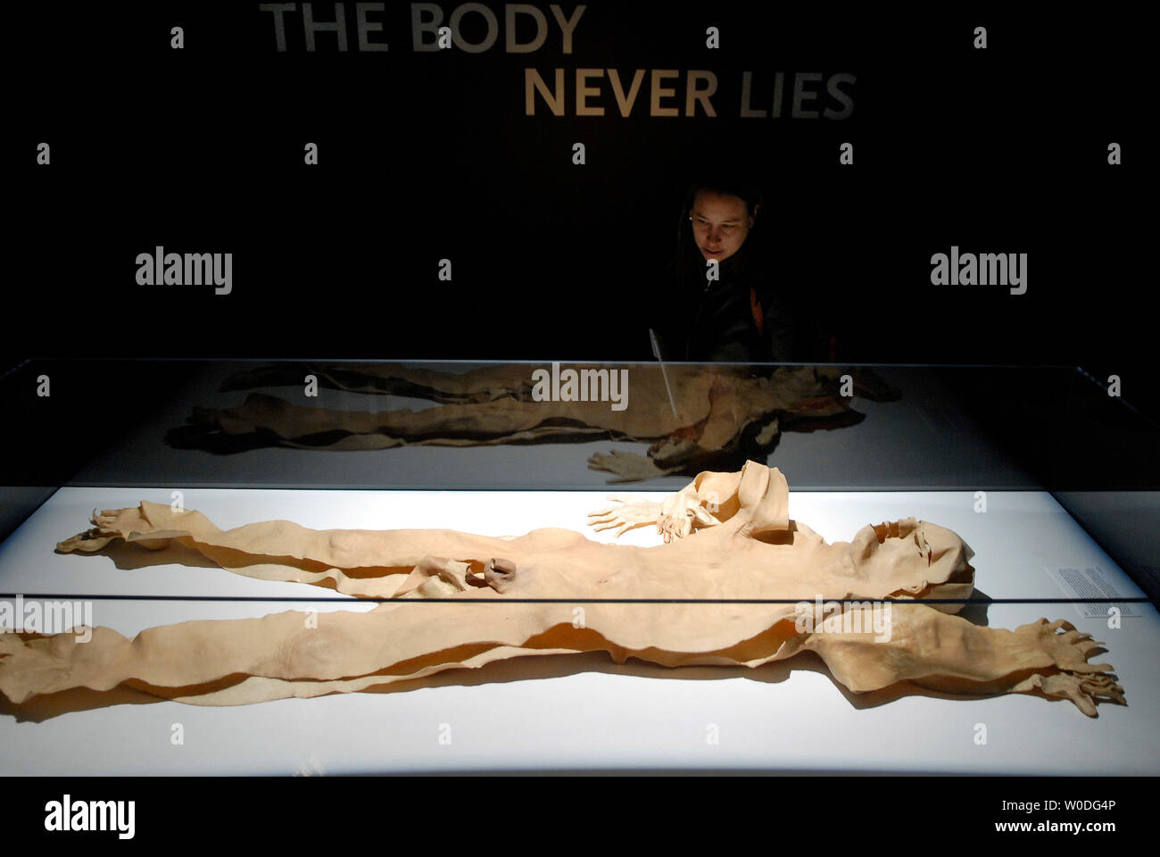A woman looks at human skin on display in "Bodies...The Exhibition" at ...