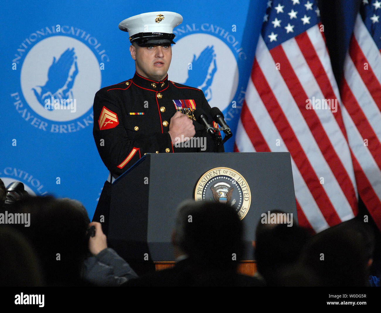 Marine Corporal Michael Blair leads participants in the Pledge of ...