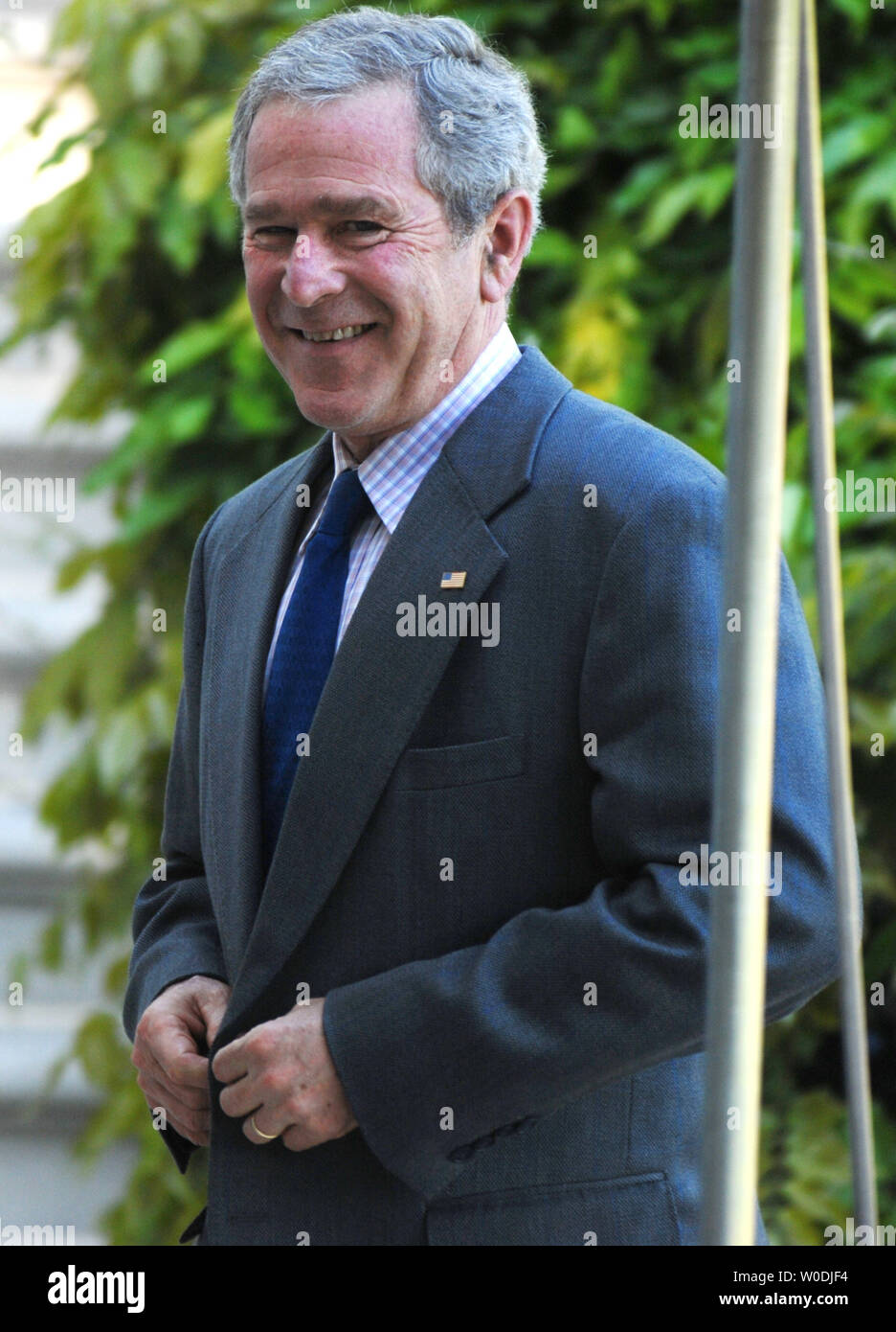 U.S. President George W. Bush smiles to the press as he walks towards ...